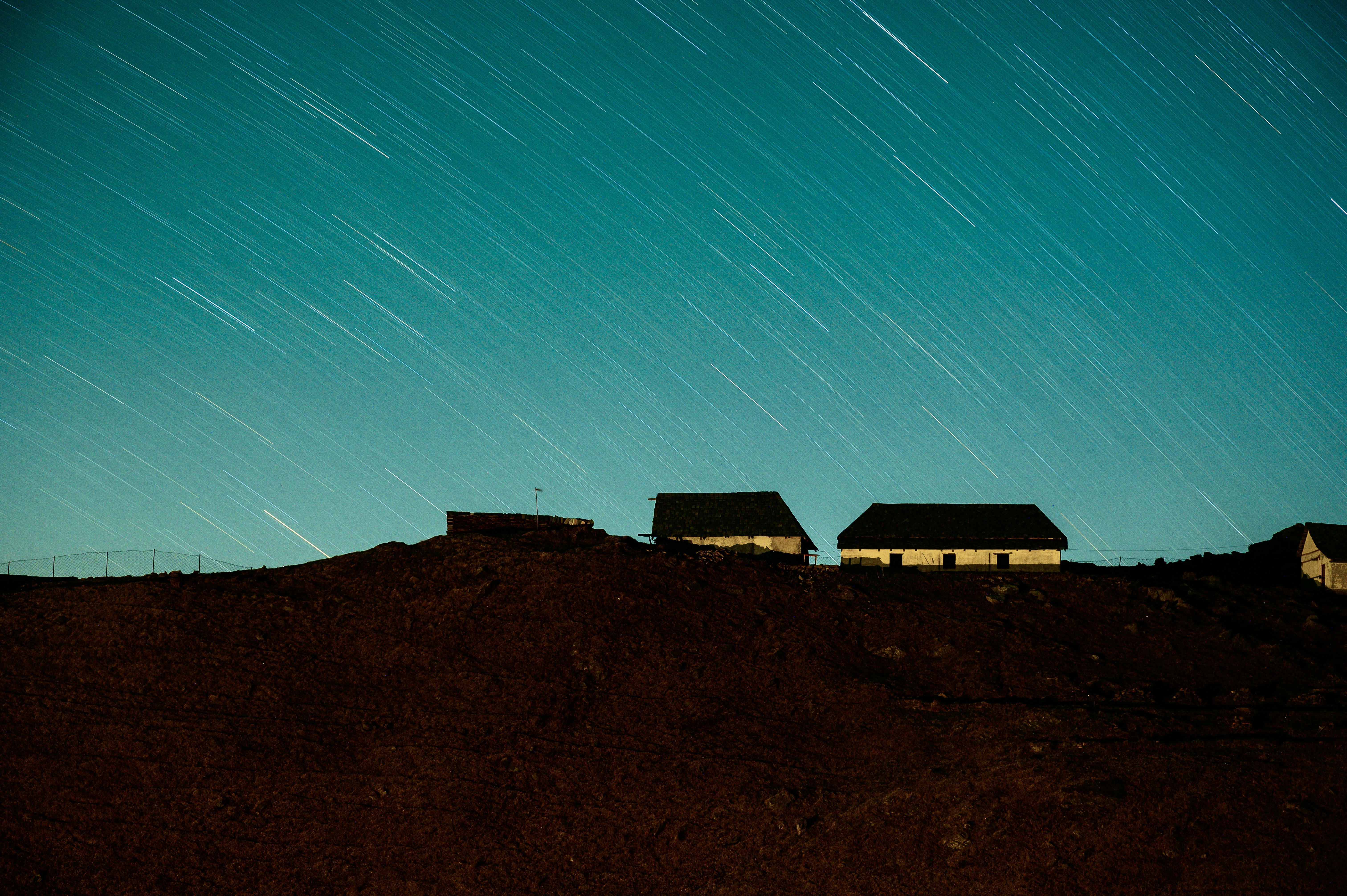 Skyward Trains Over a Hilltop Village Silhouette