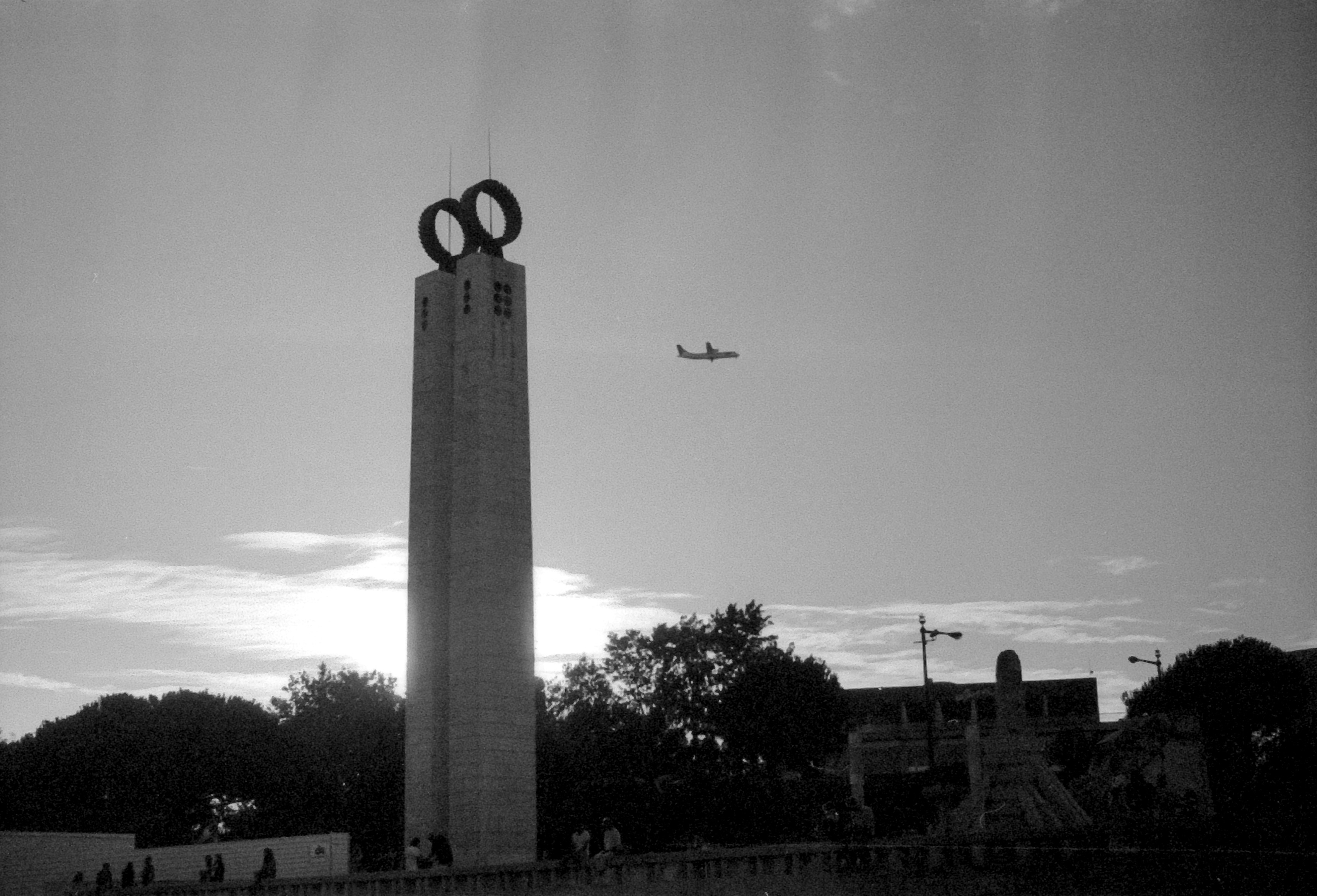 Twin Rings Crown a Quiet Obelisk at Dusk