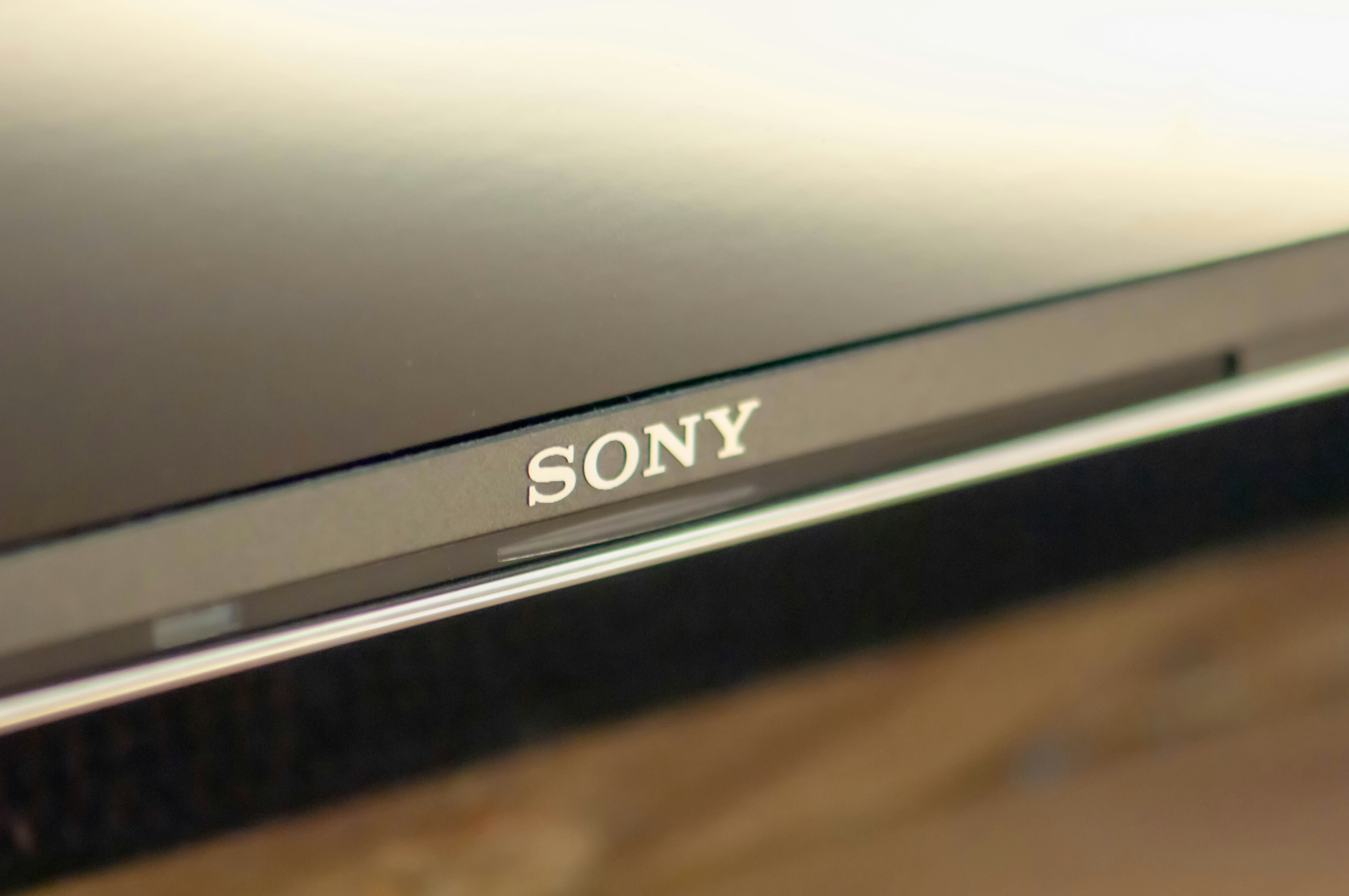 Close-up of a sleek Sony logo on a modern device, highlighting the brand's commitment to design and technology.