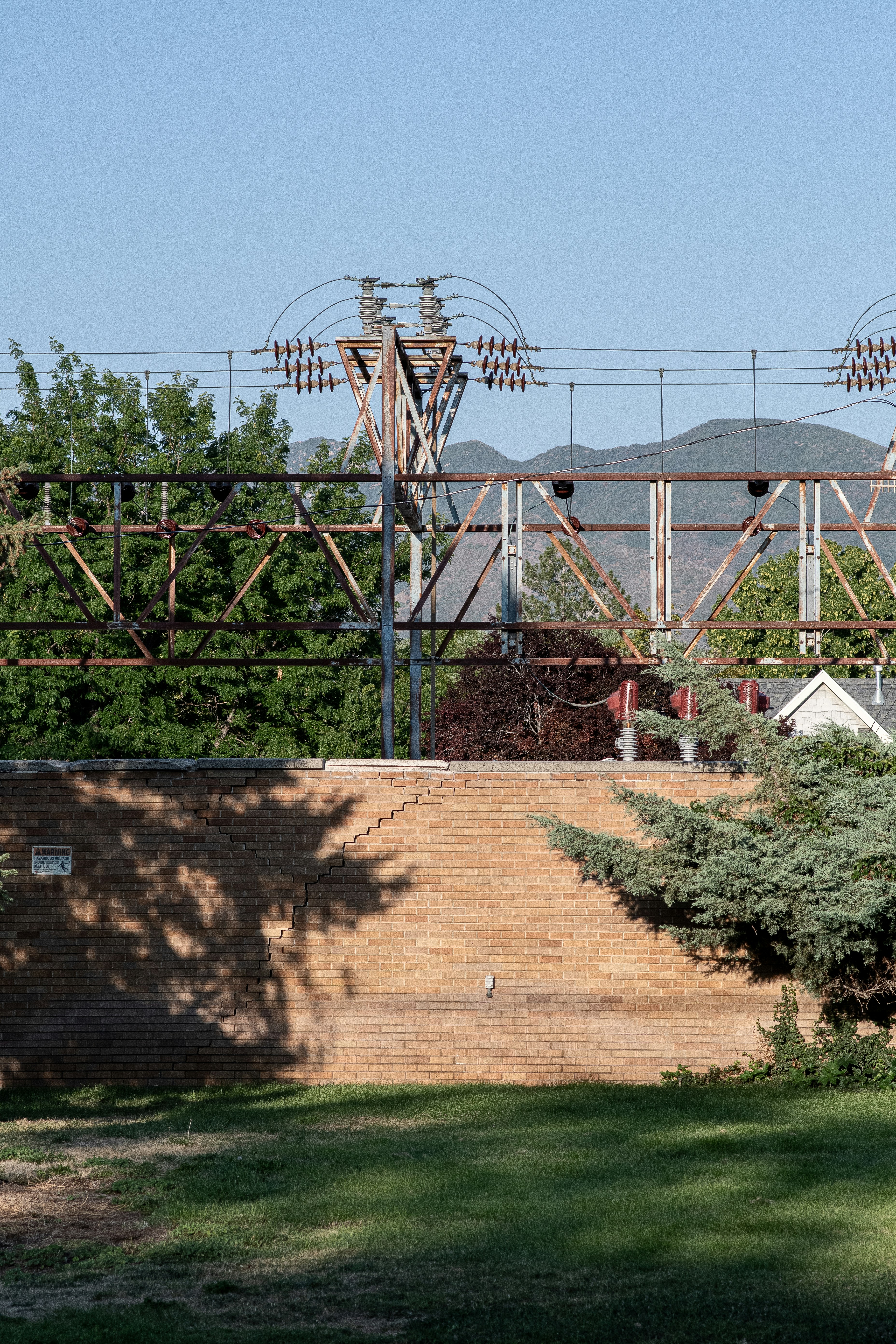Power Lines over a Quiet Brick Wall: A Midday Urban Landscape