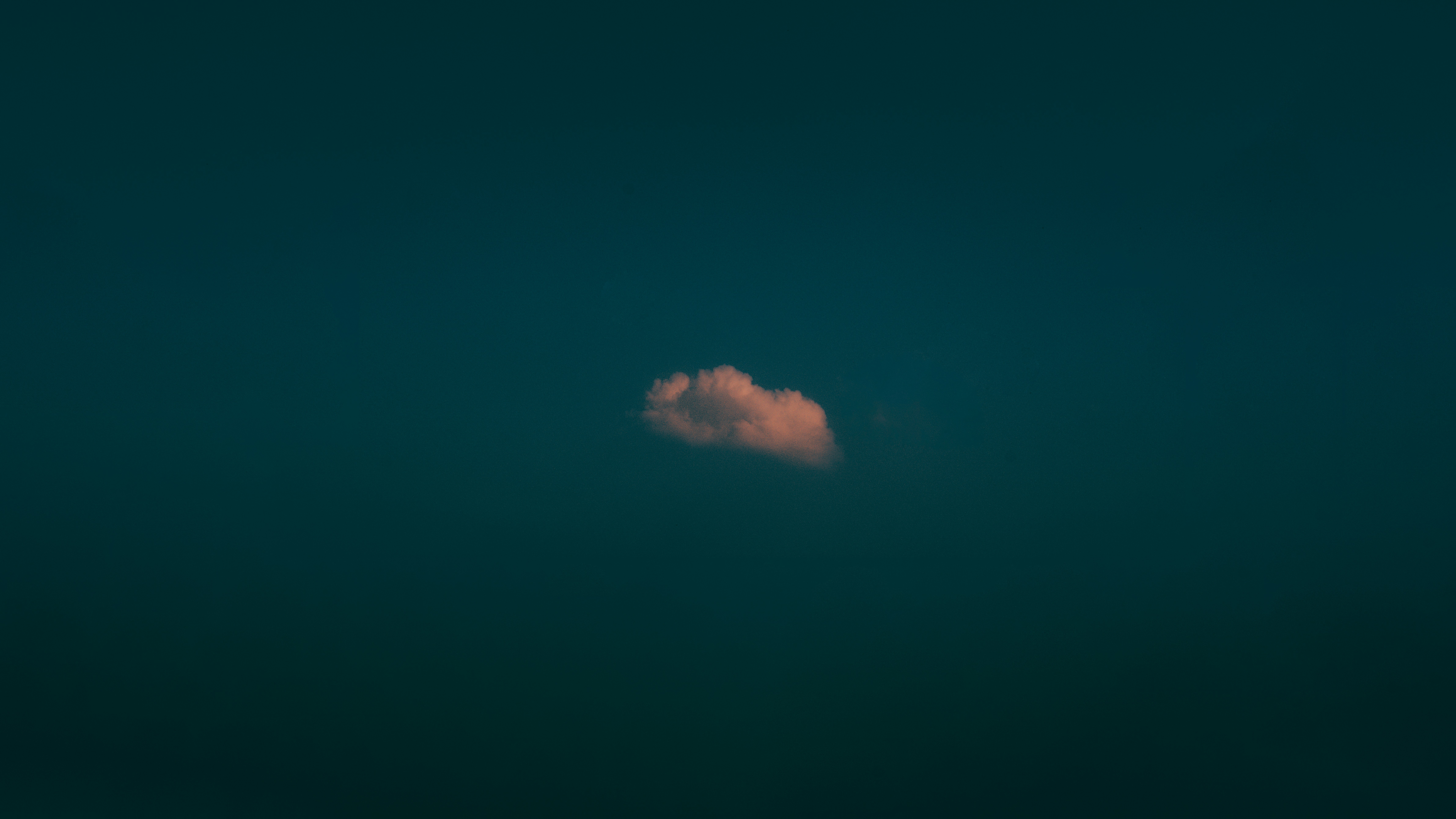 Coral-tinged Cloud Adrift in Deep Teal Twilight