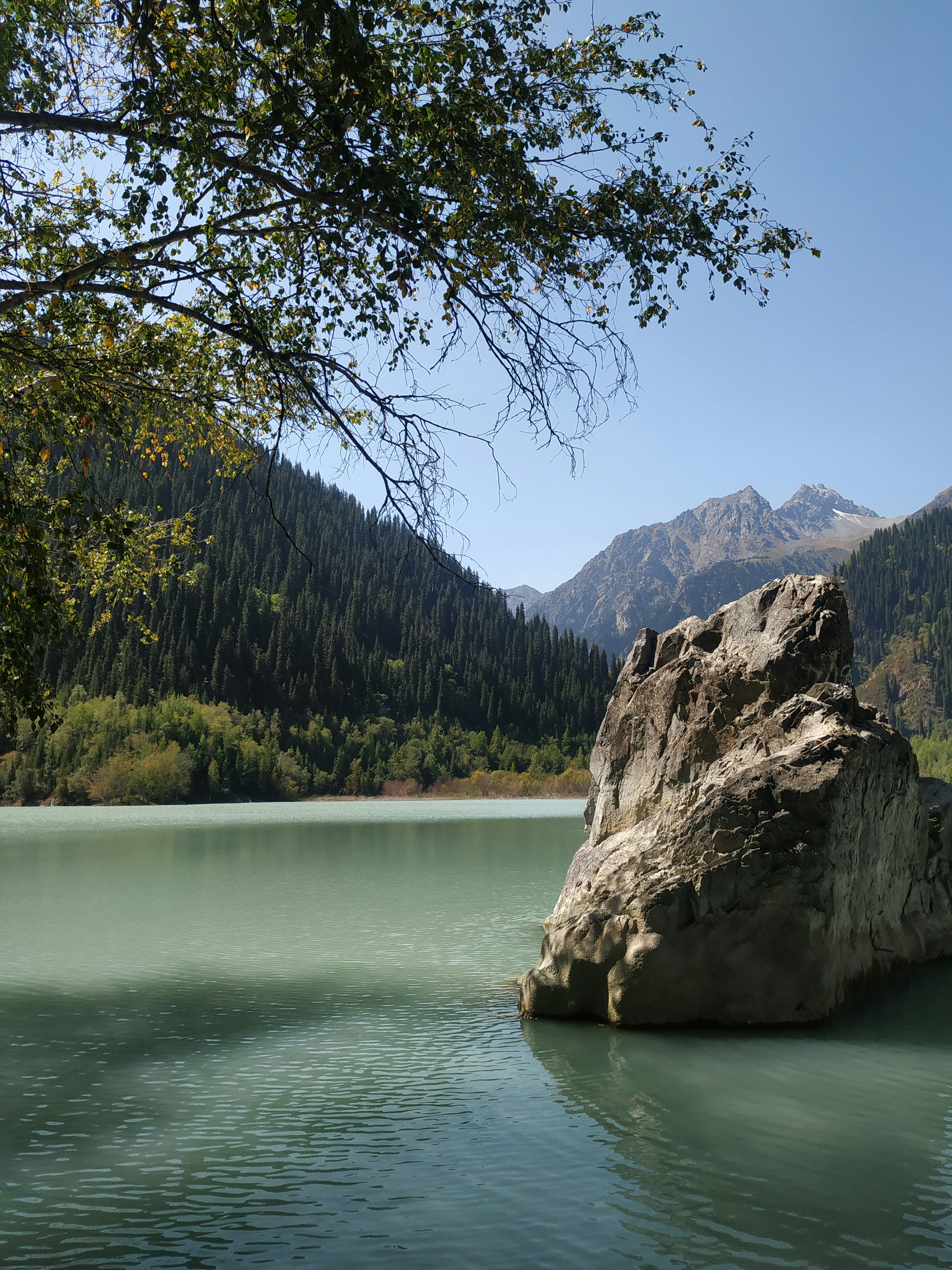 Granite Sentinel Over a Turquoise Alpine Lake