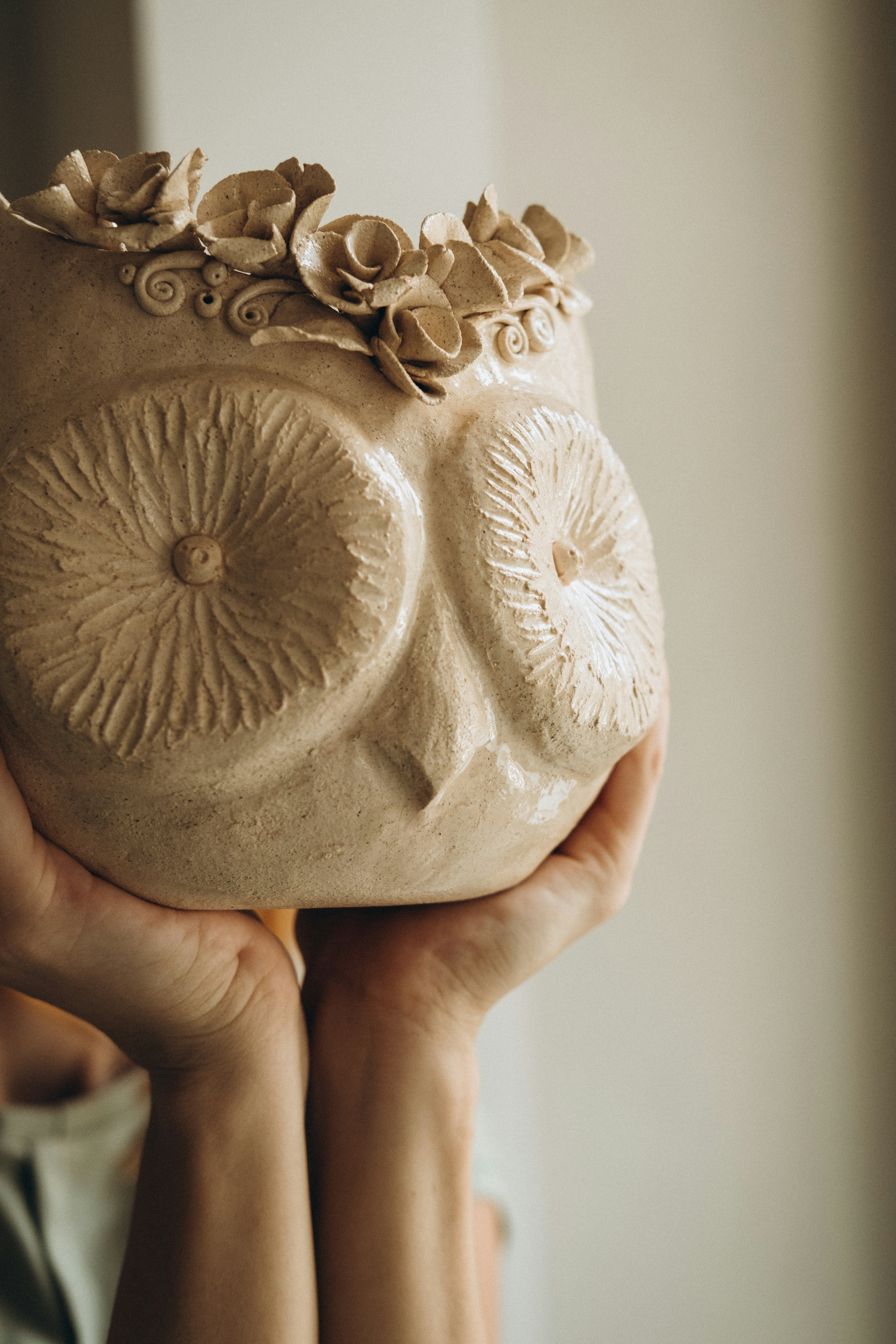 Floral Crowned Ceramic Owl Cradled in Soft Light