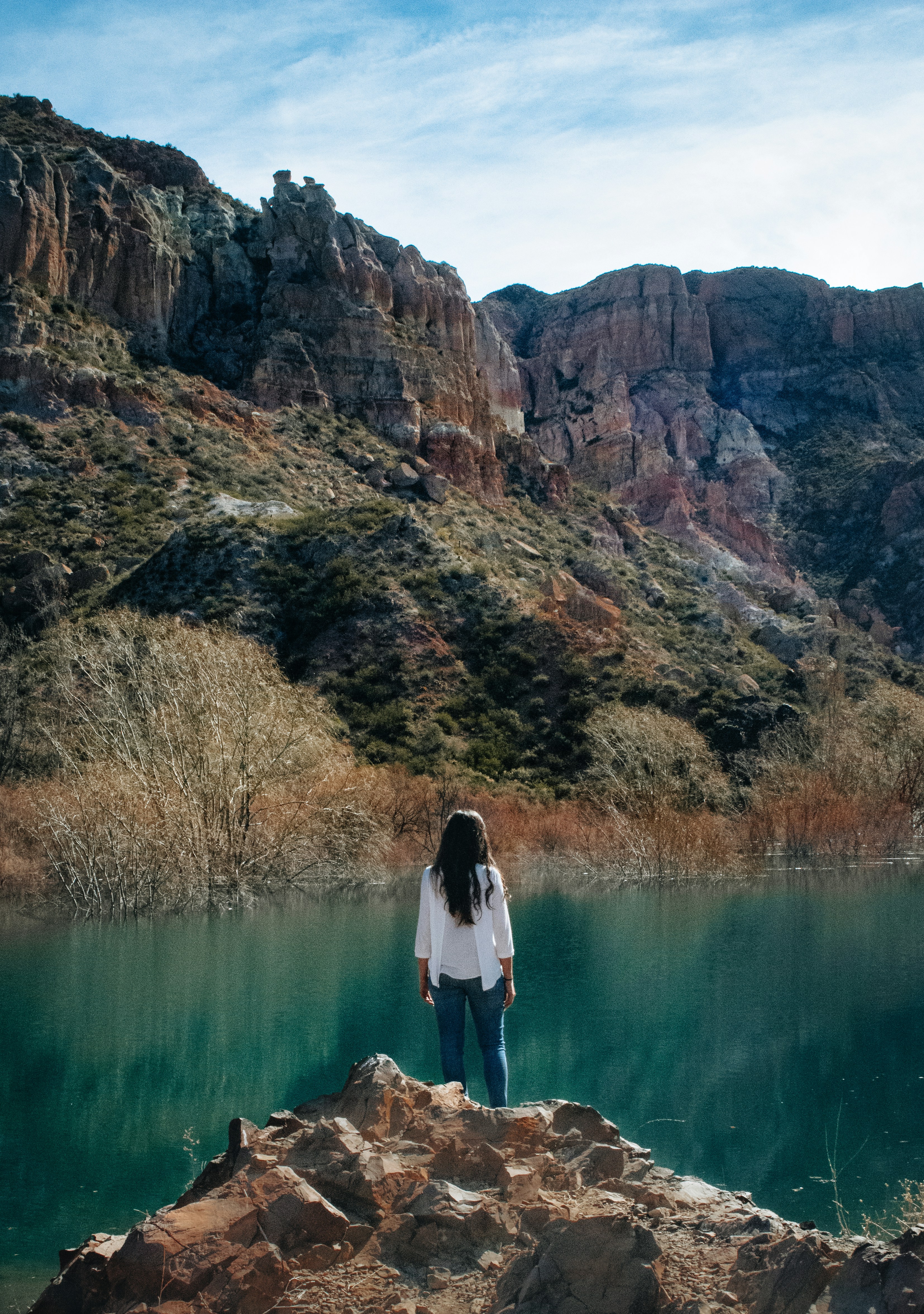 Edge of Turquoise Quiet: A Figure at the Foot of a Rugged Canyon