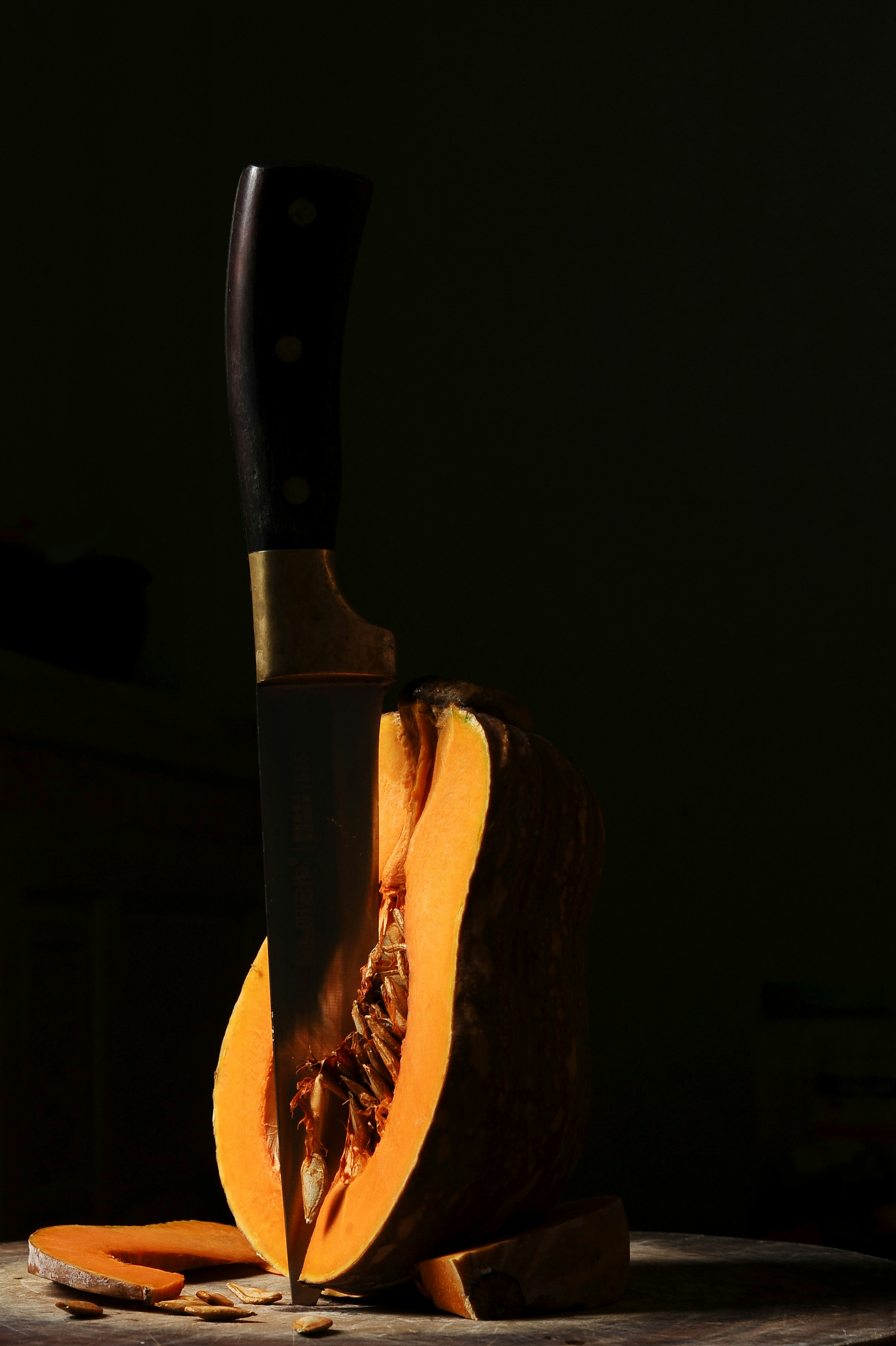 Midnight Carving: A Knife Pierces a Pumpkin's Quiet Core