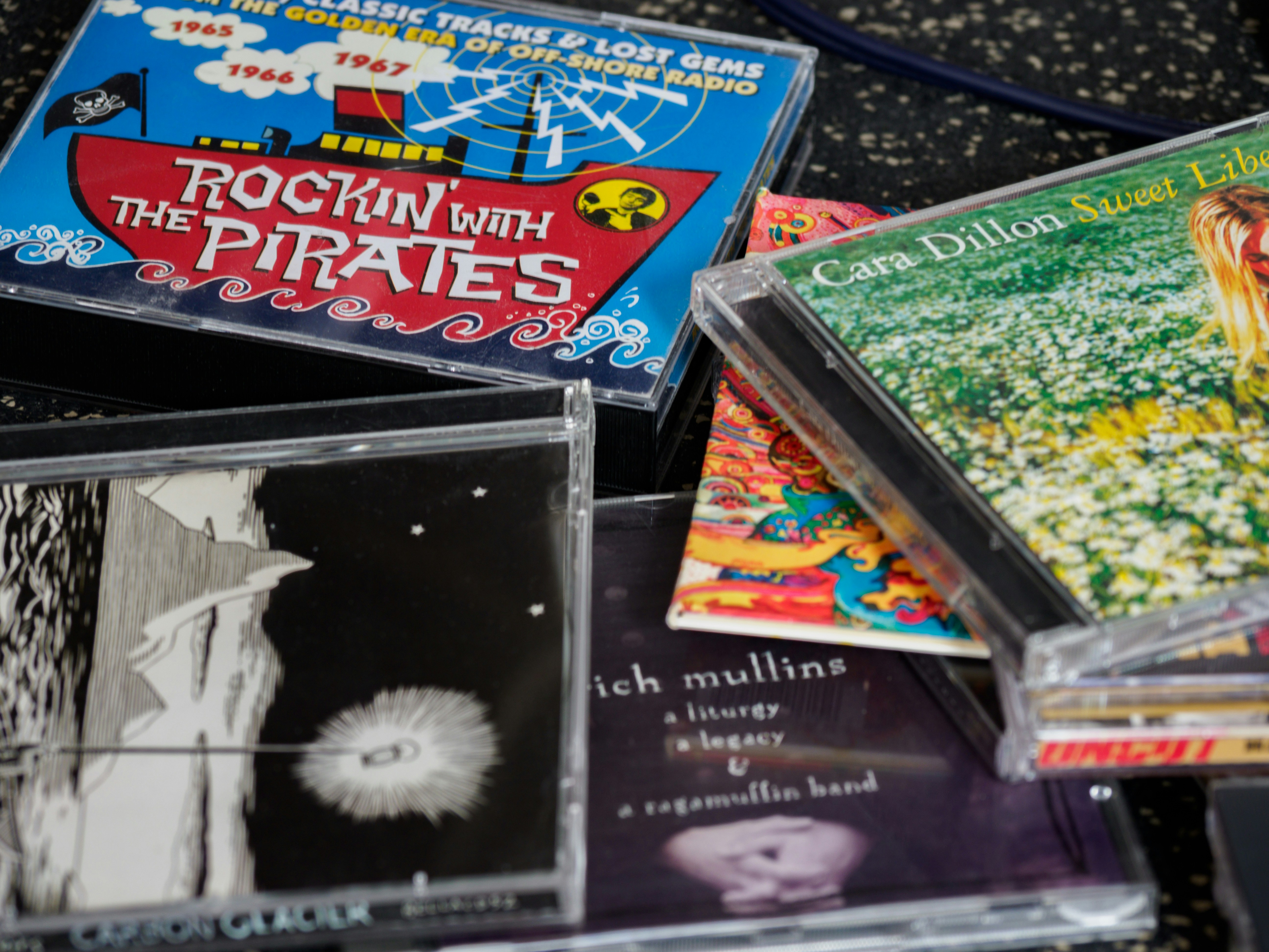 A pile of cds sitting on top of a table photo – Free Book Image on Unsplash