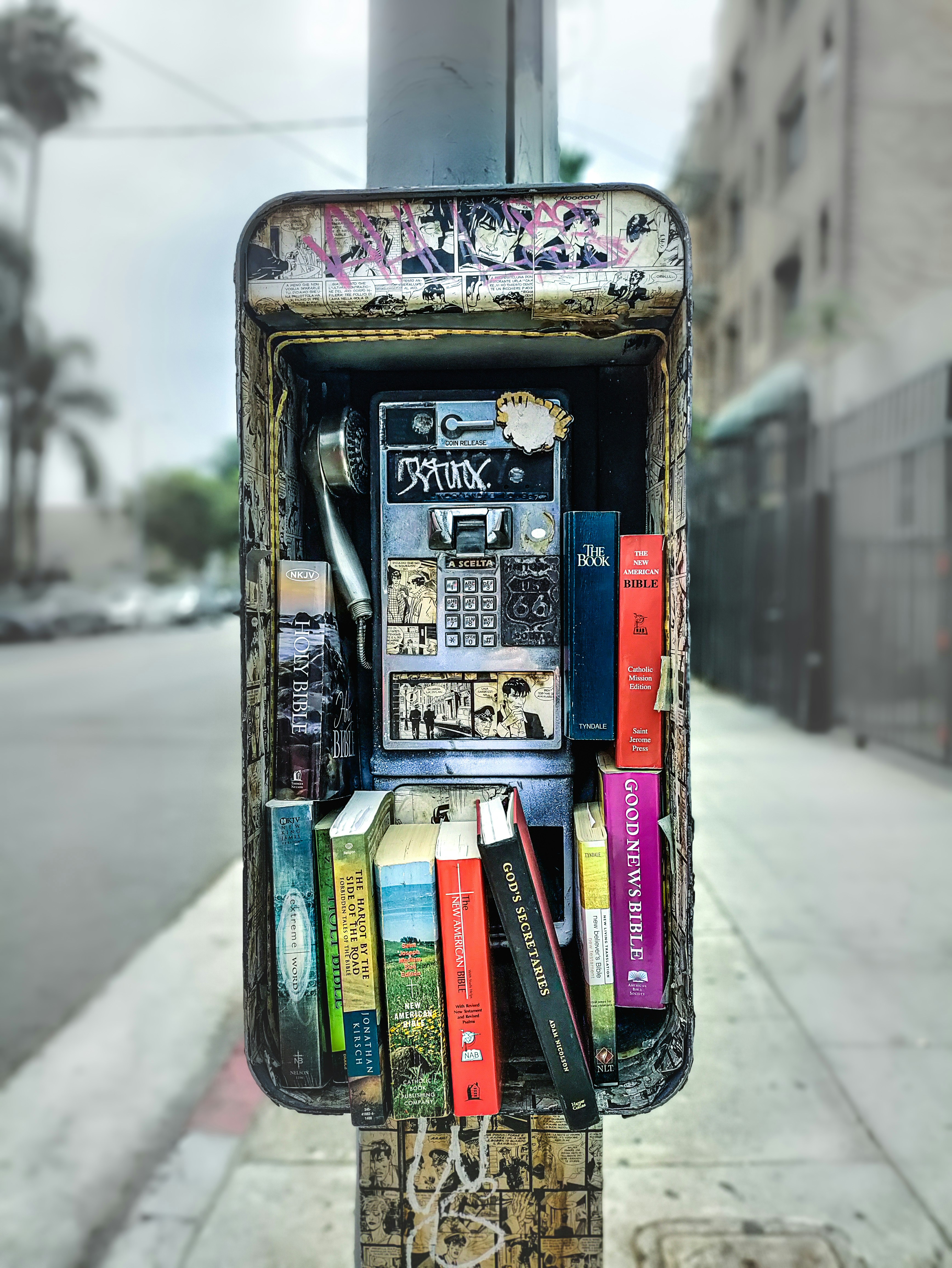 black and blue electronic device on top of books