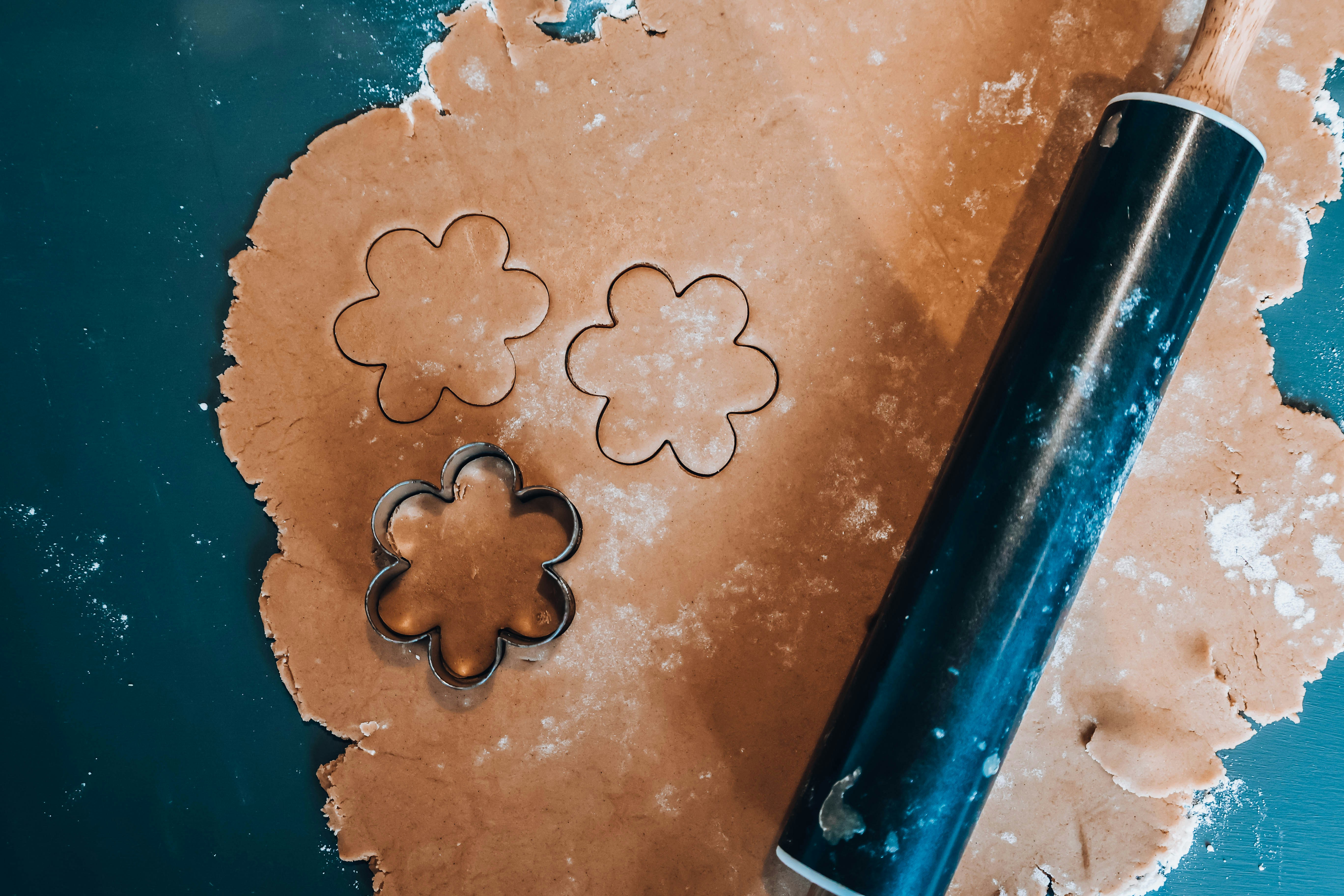 Floral Cookie Cutouts on Teal Dough, Ready for the Oven