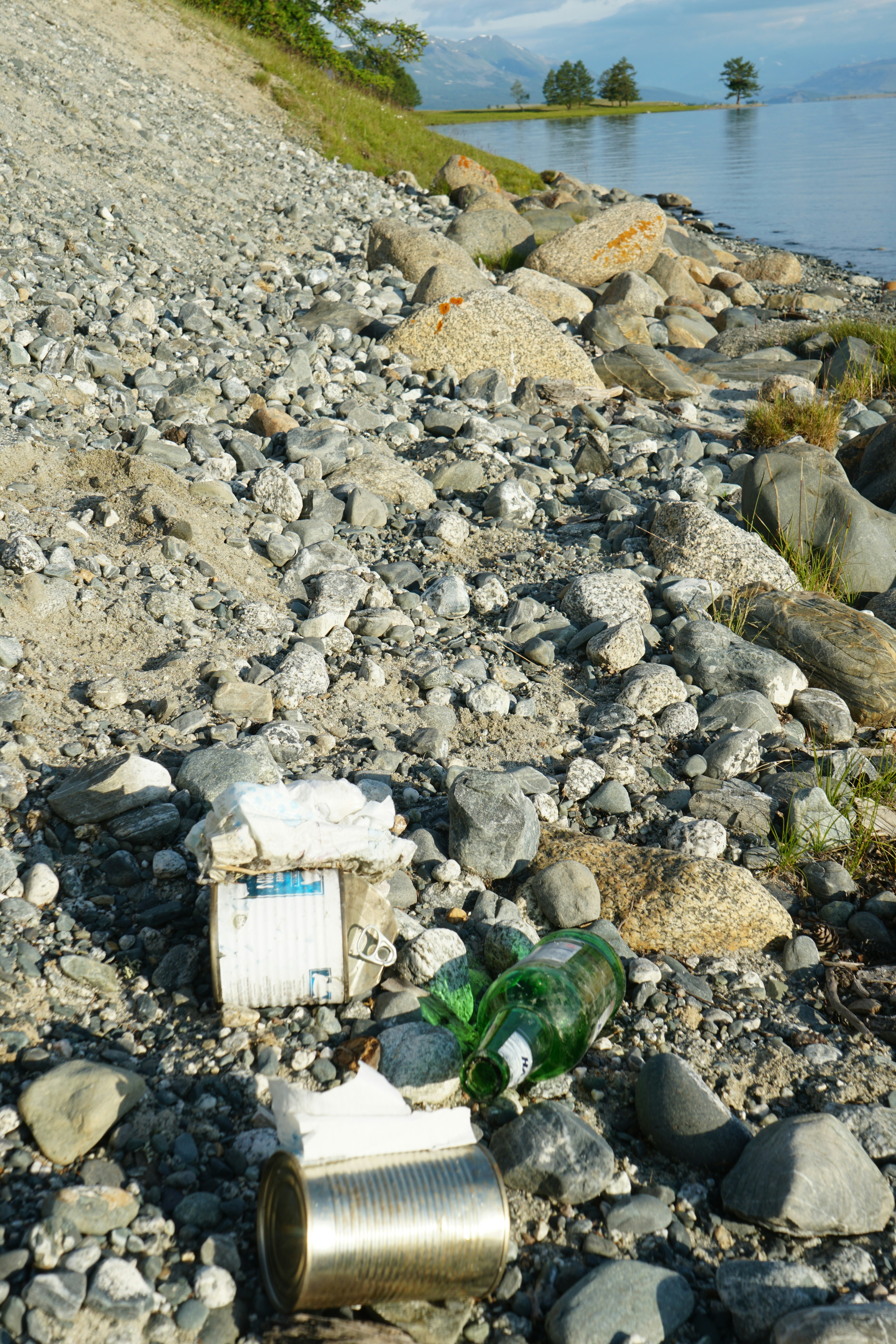 white wooden house on rocky shore during daytime