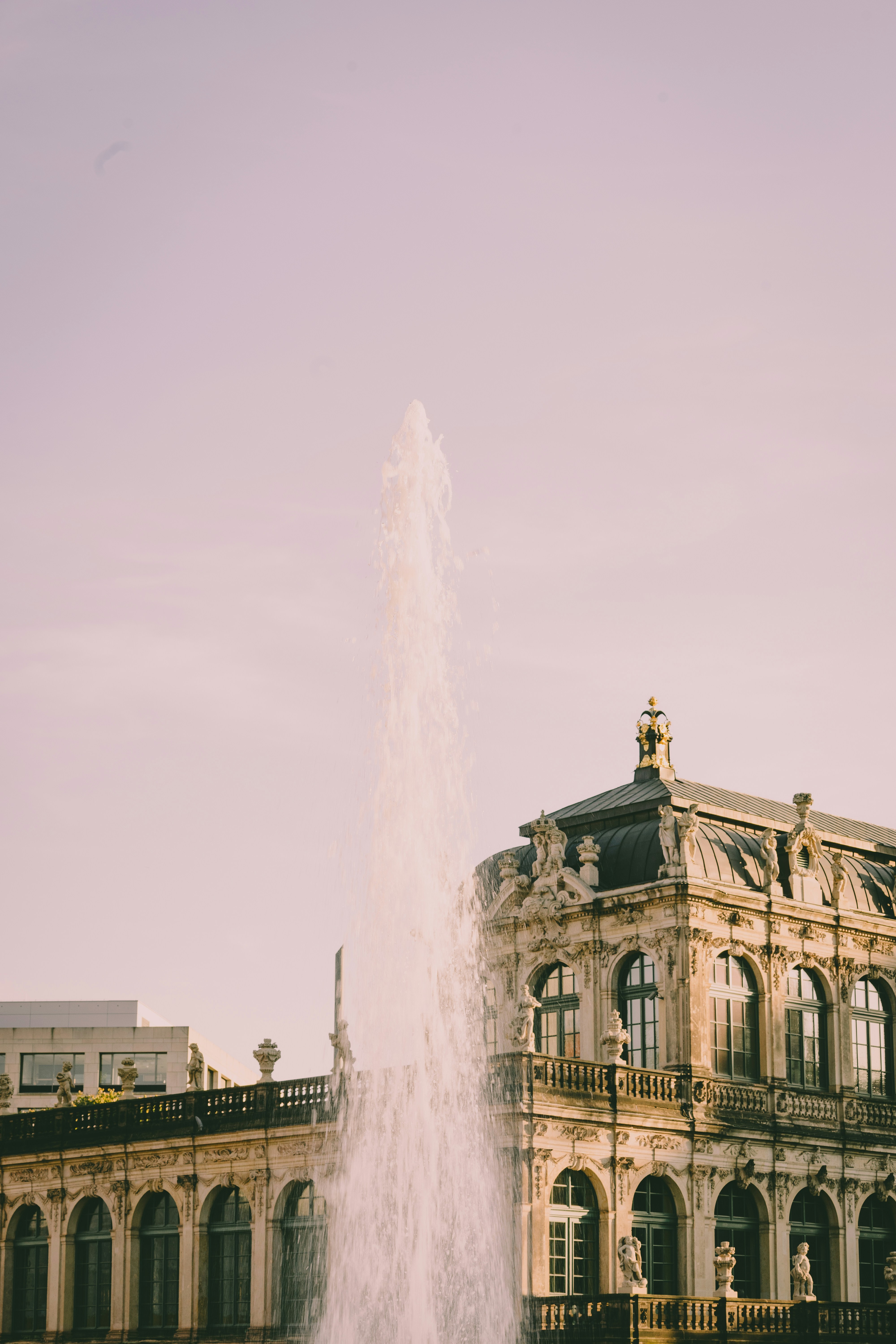 water fountain near white concrete building during daytime