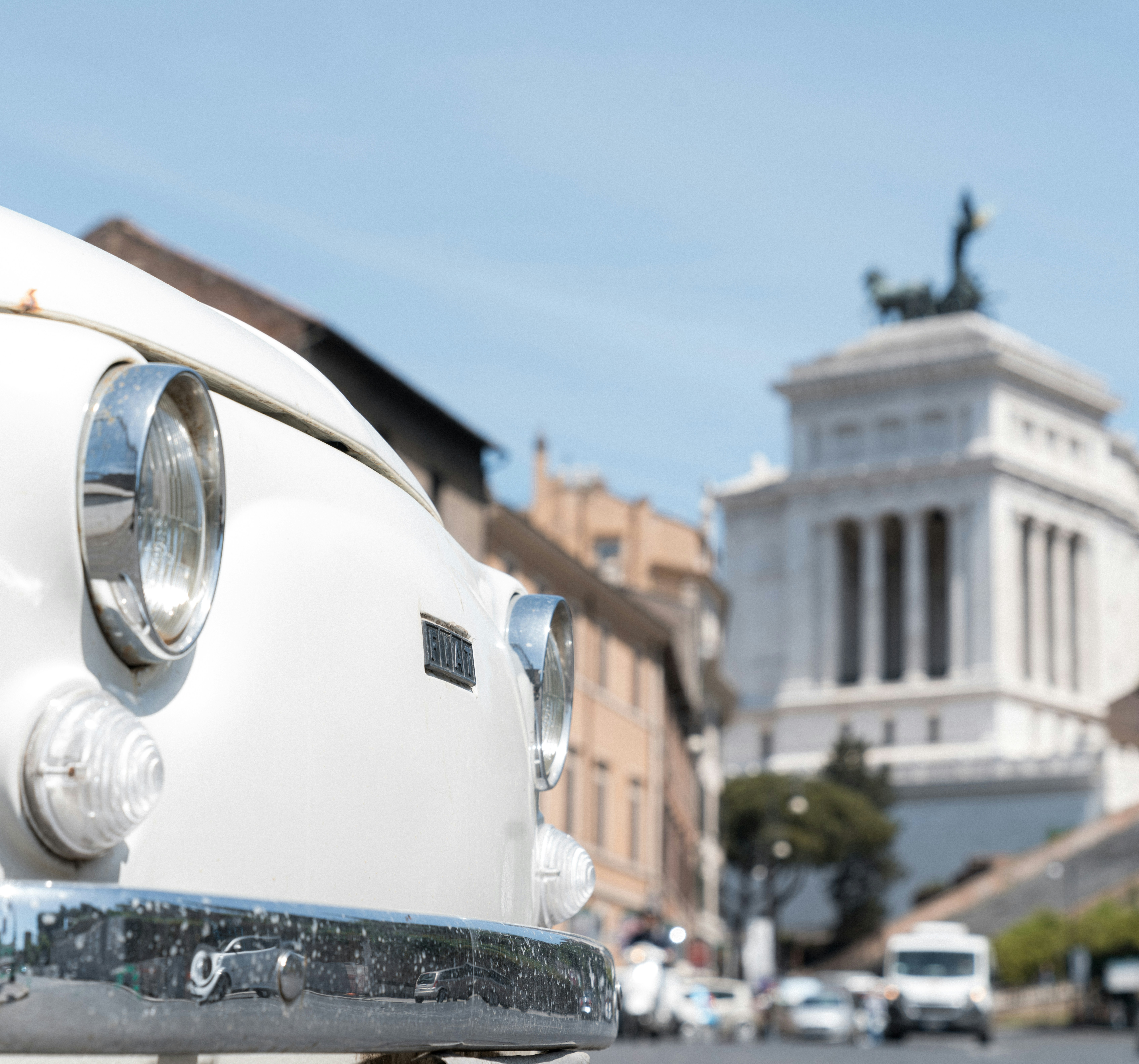 White Classic Fiat 500 Framed by Rome's Monumental Street