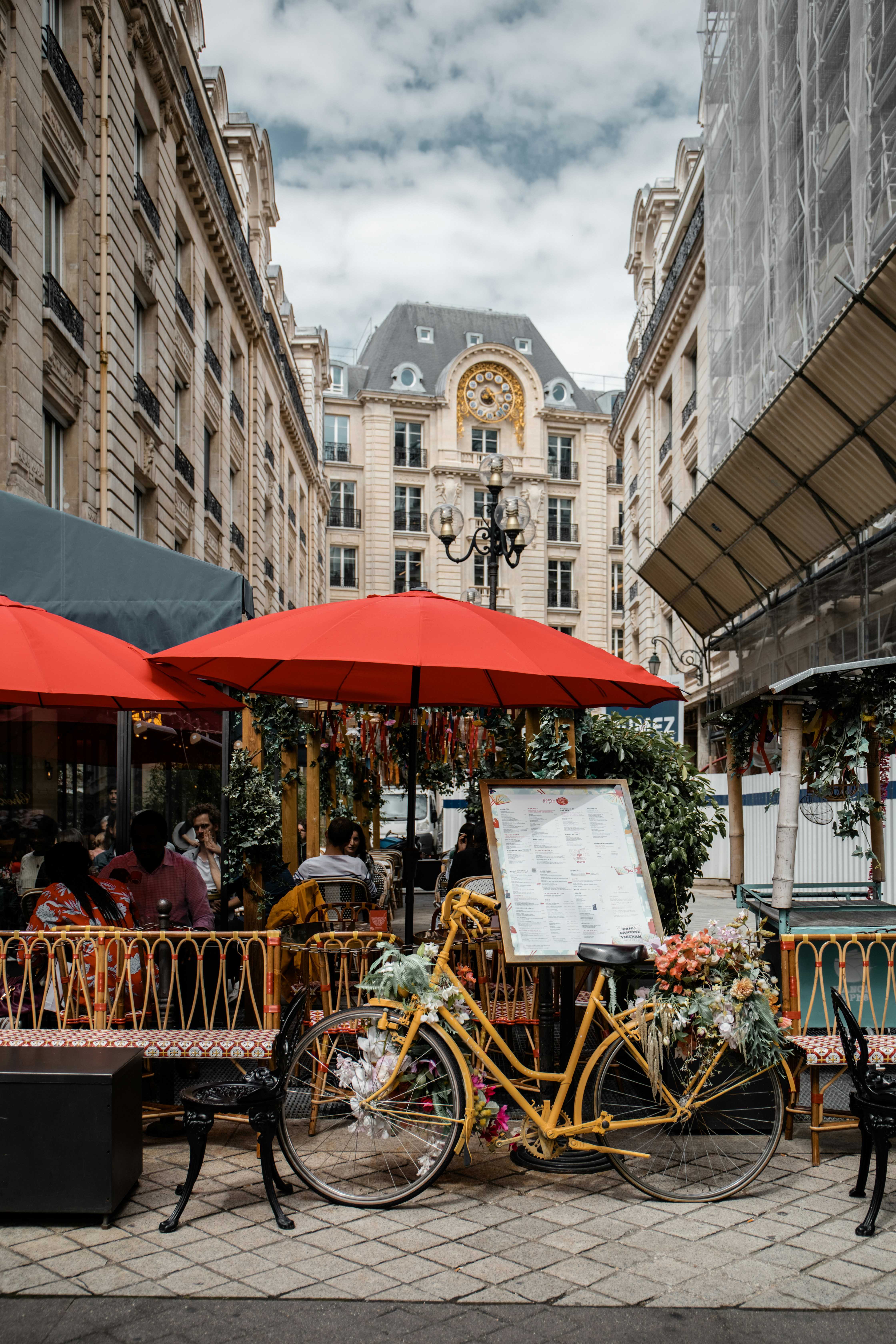 Blooming Bicycle under Scarlet Parasols in a Historic Arcade