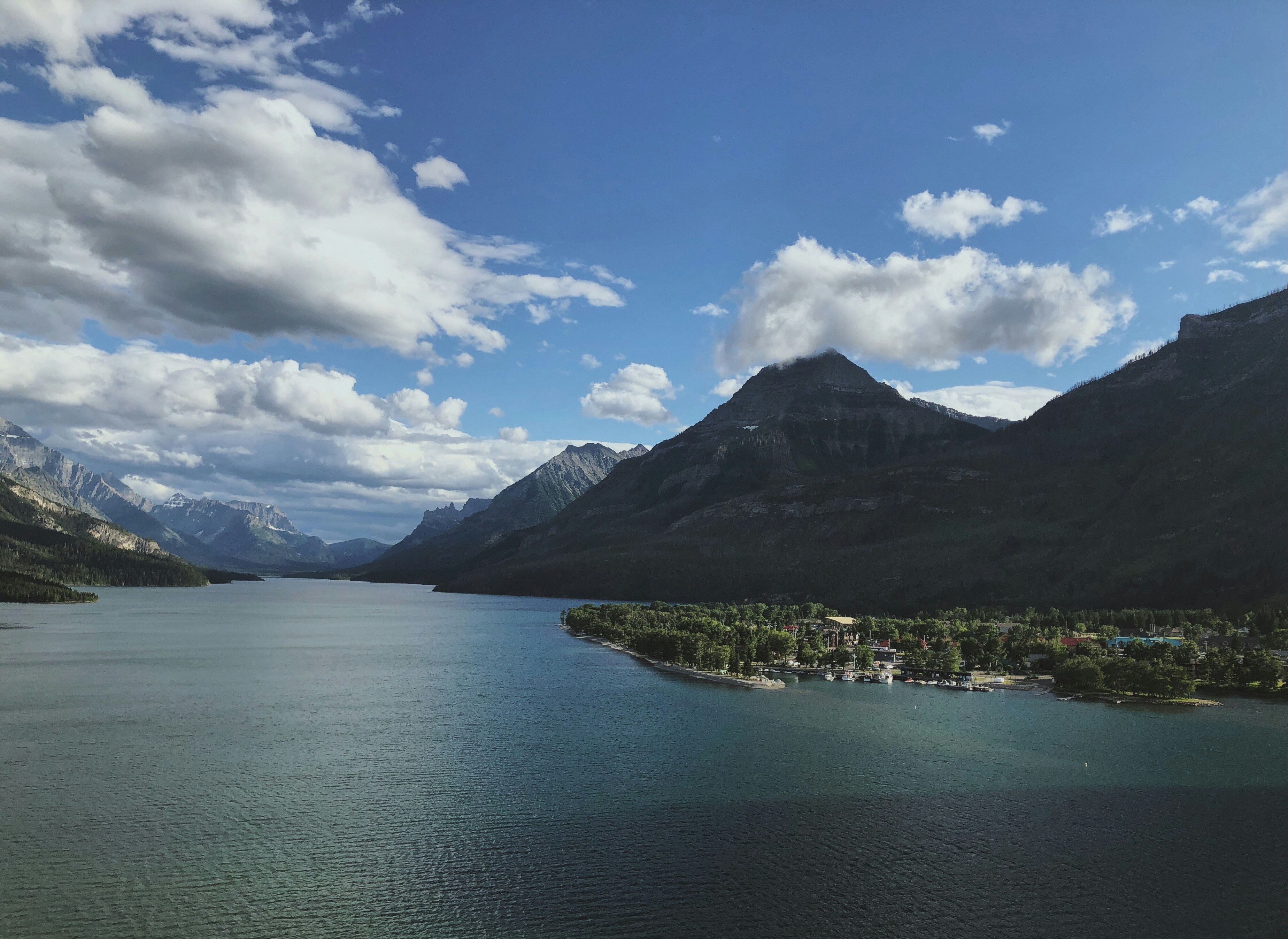Lakeside Village Between Rugged Peaks Under a Bright Alpine Sky