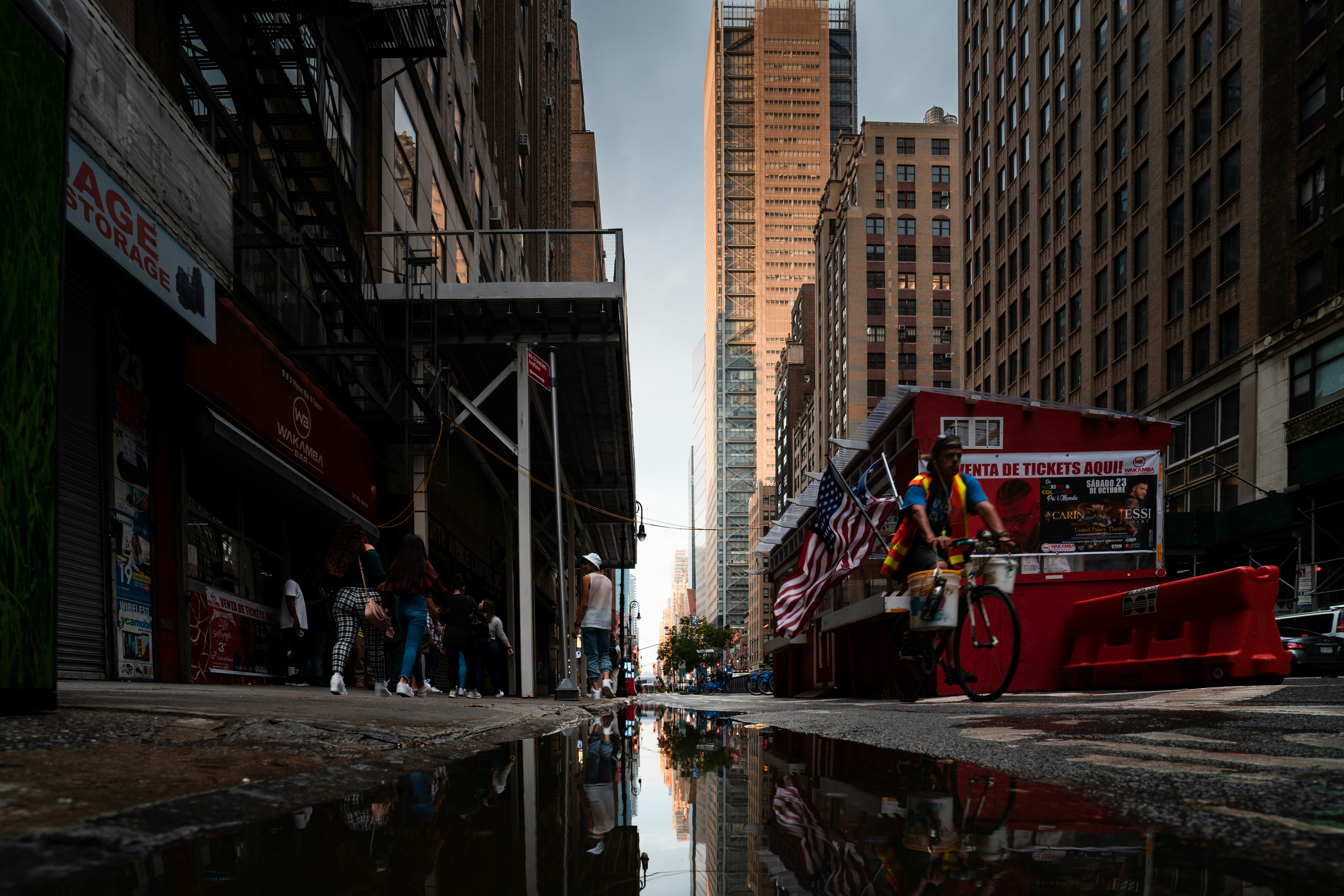 People walking on sidewalk near high rise buildings during daytime ...