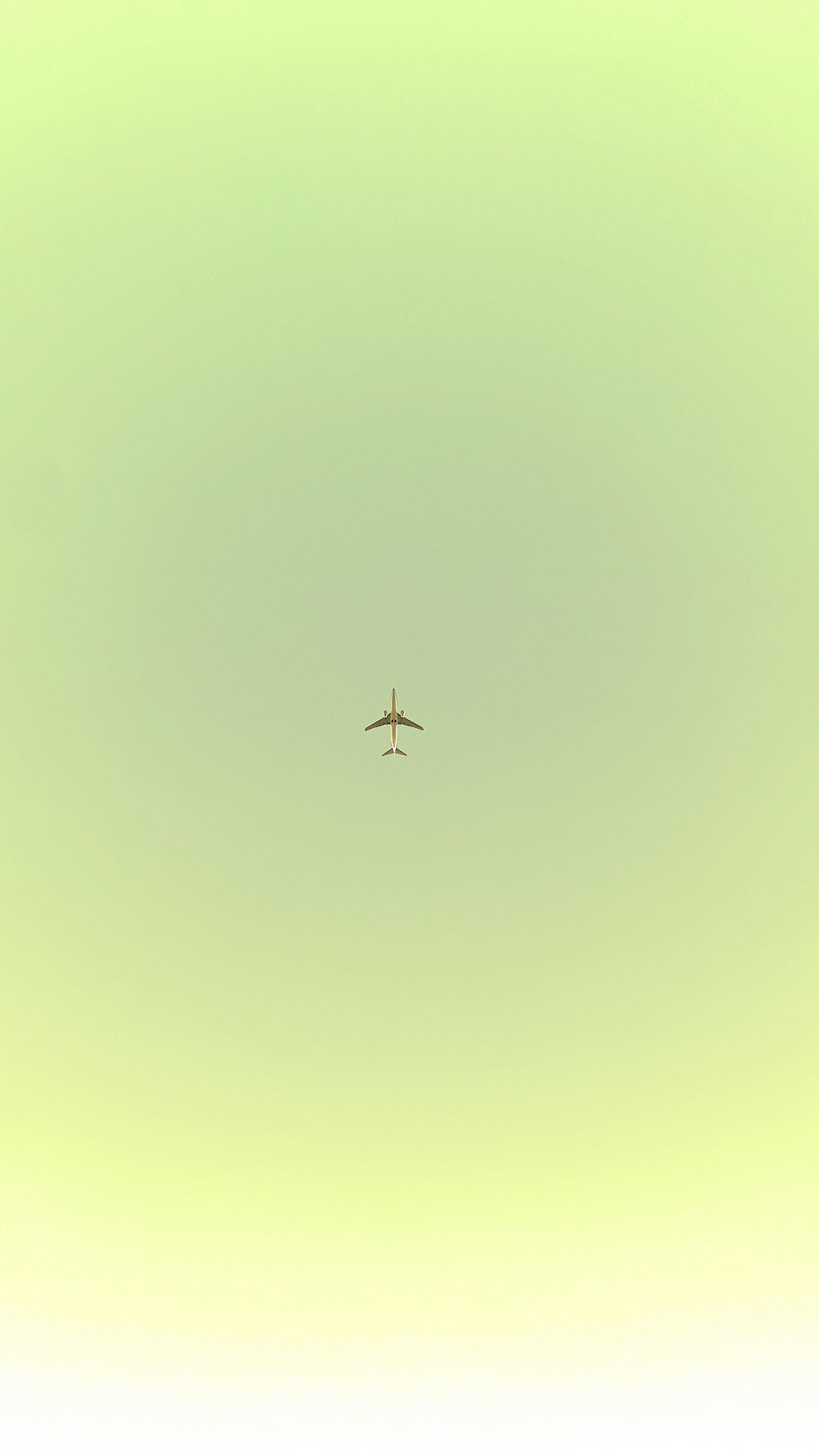 Commercial airplane gliding through a soft pastel sky, evoking a sense of freedom and tranquility.