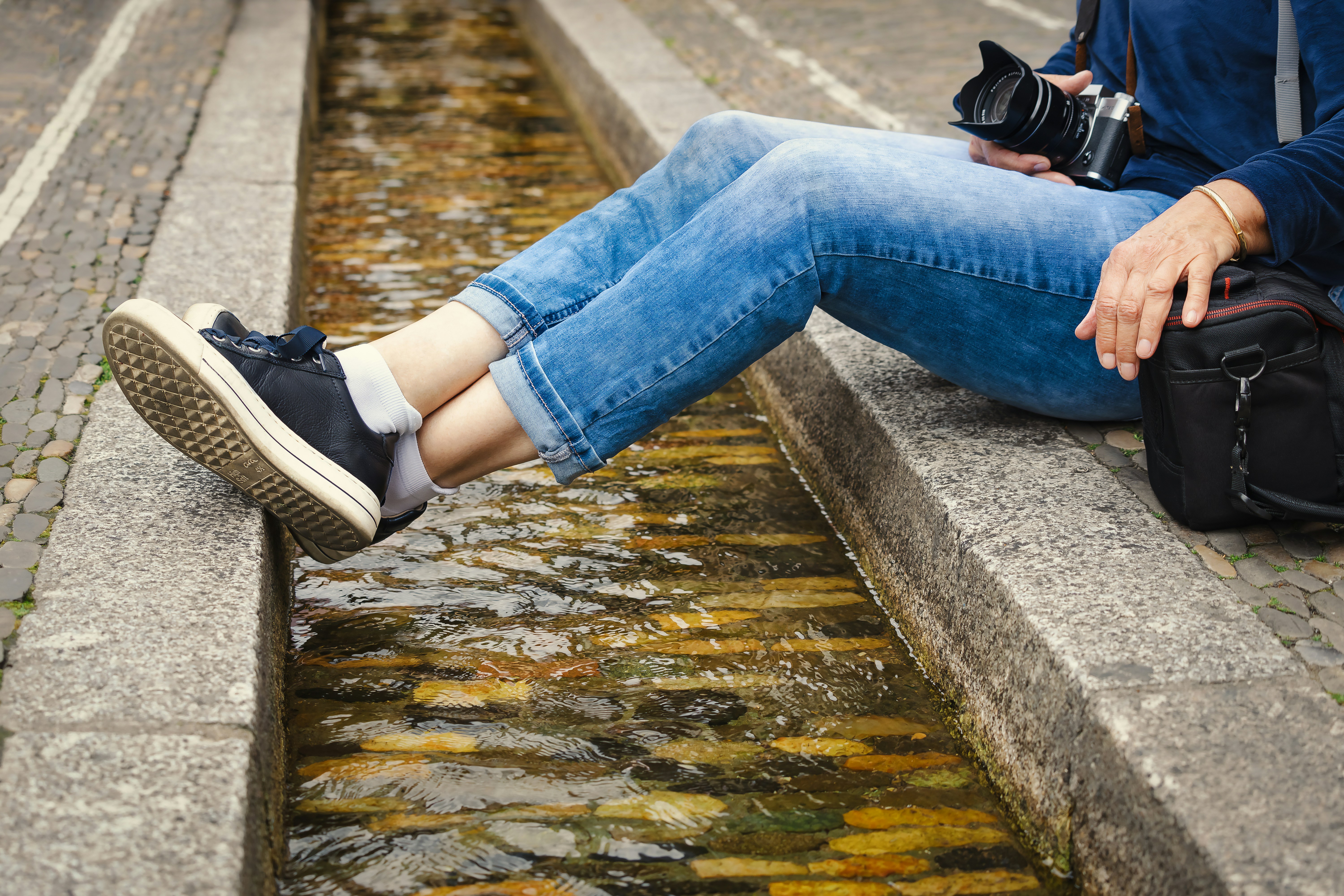 Blue Jeans and Quiet Steps by a Water Channel