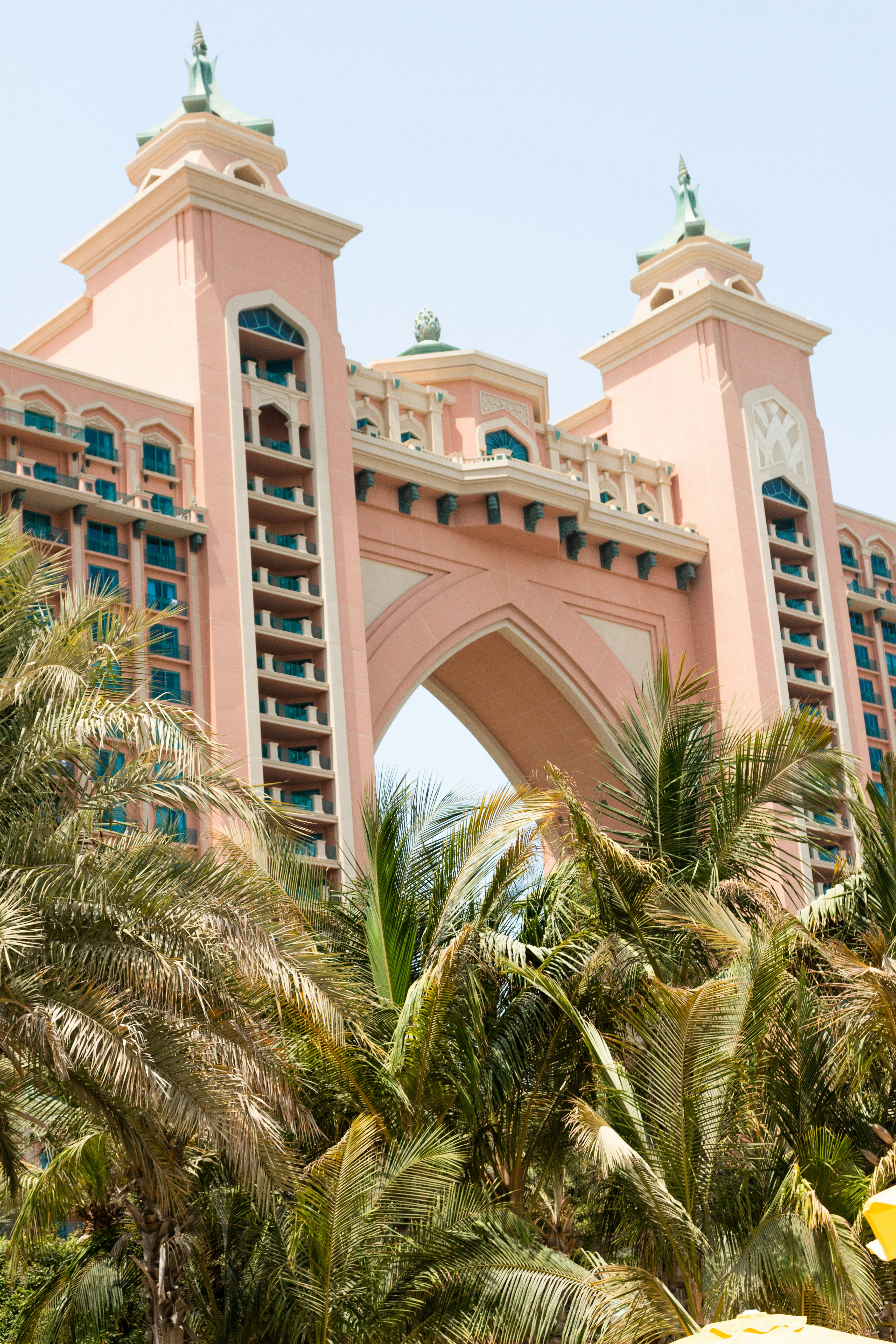 The Pink Gateway: A Tropical Archway Framed by Palms