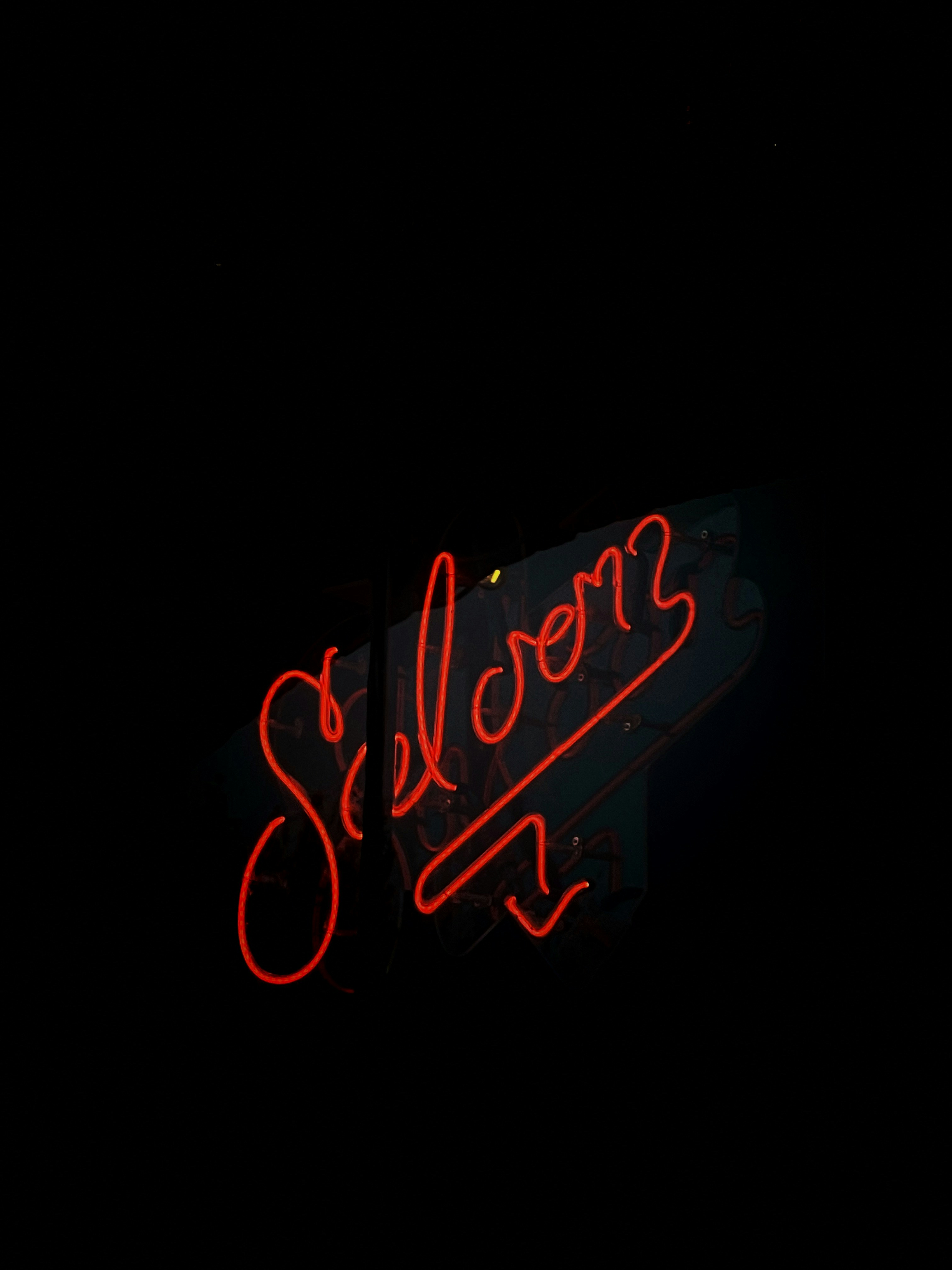 Red Neon Script in the Dark