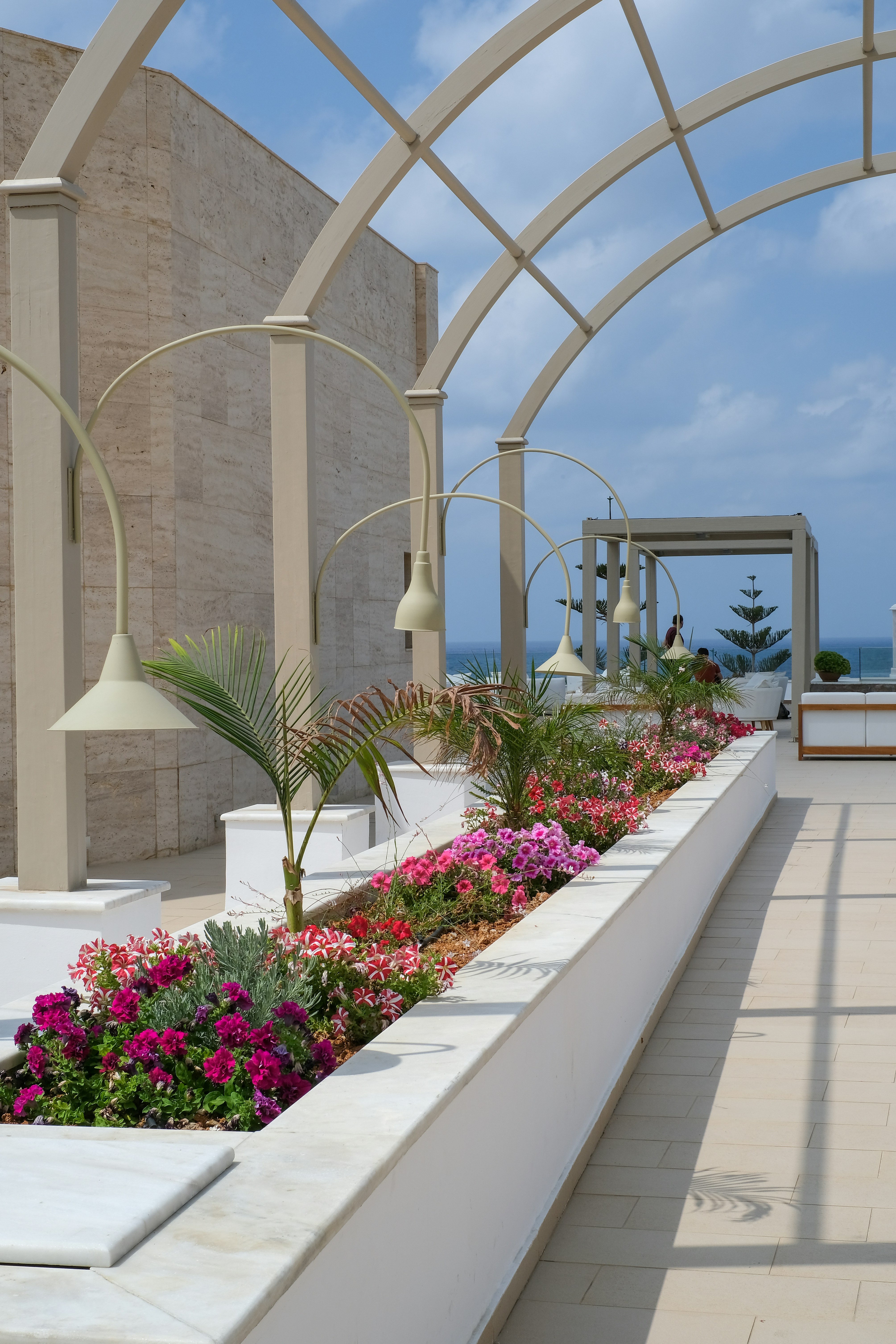 Seaside Archway Corridor: Bloom-filled Terrace Framing the Ocean