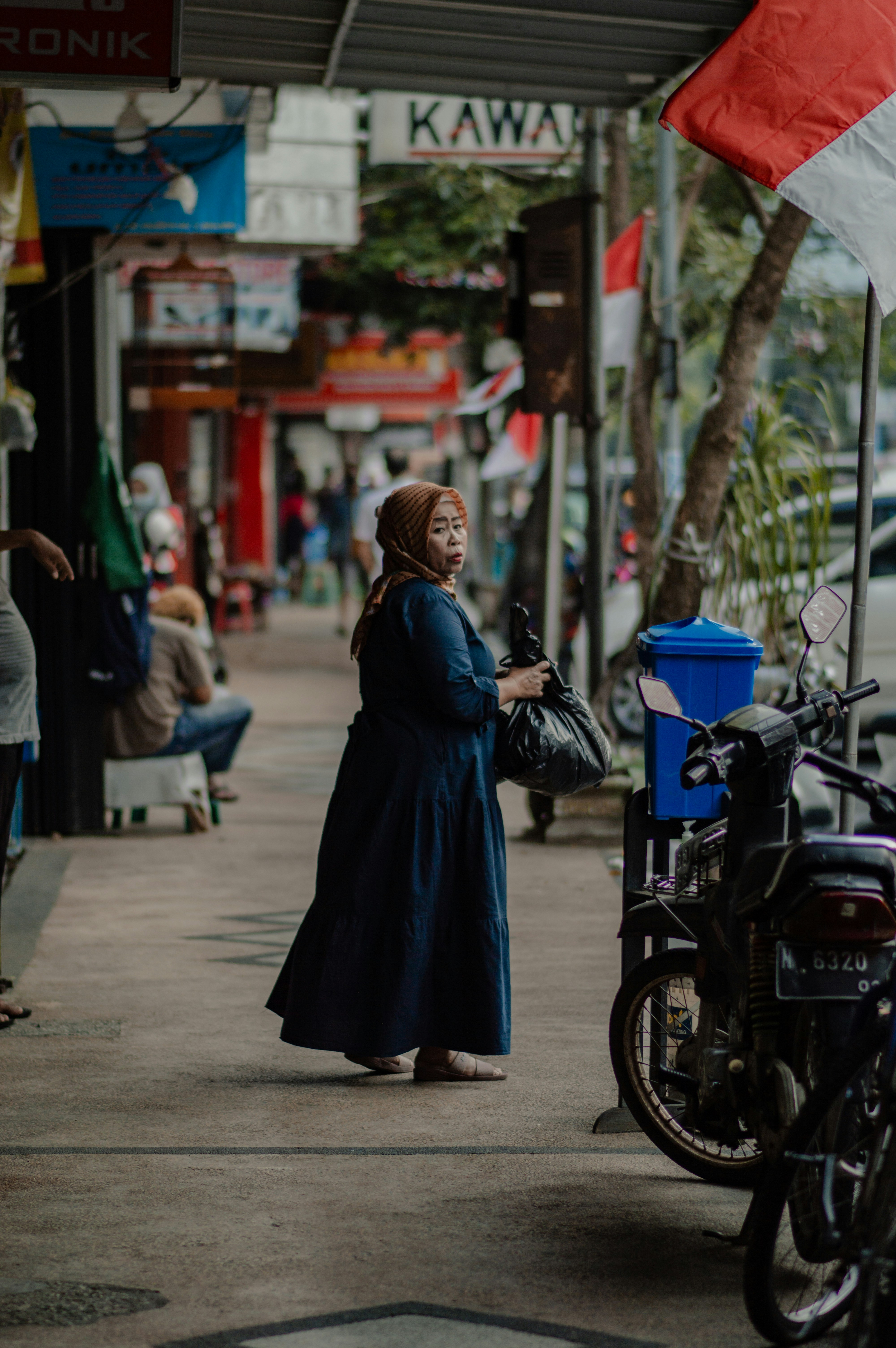 Woman in black coat standing beside black motorcycle during daytime ...