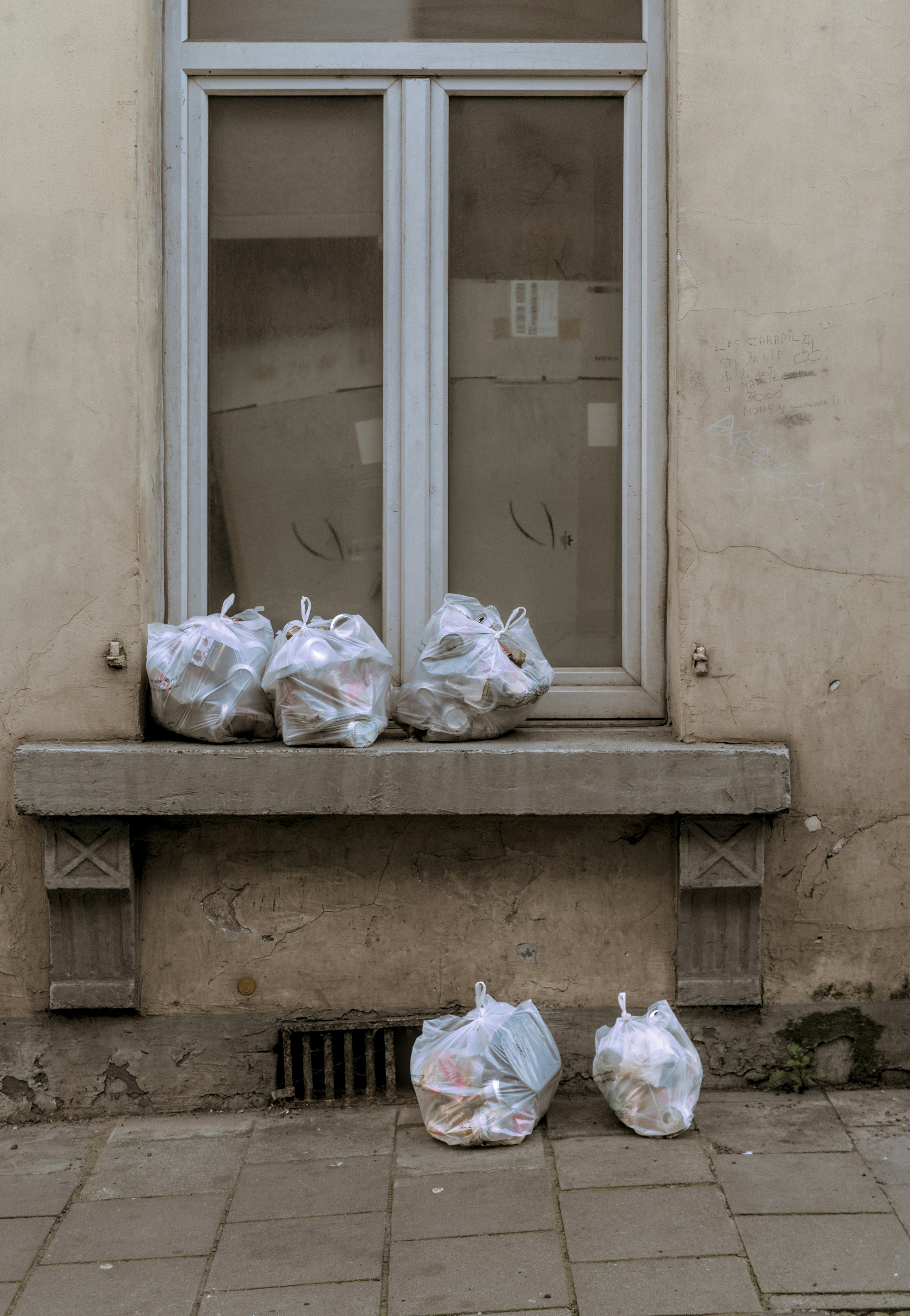 Bags of garbage sitting on a window sill photo – Free Plastic bag Image ...