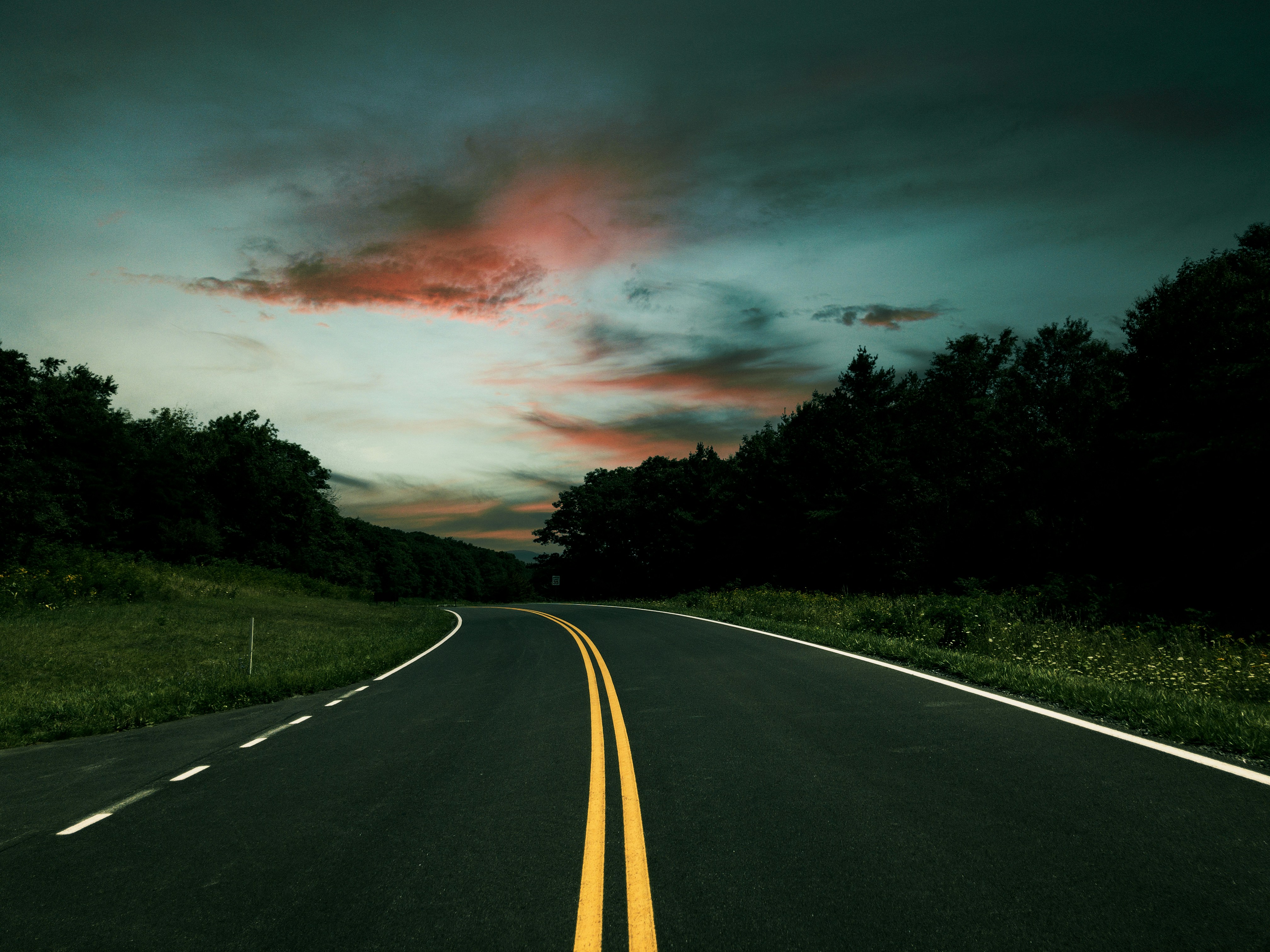 A road with a yellow line going through the middle of it photo – Free ...