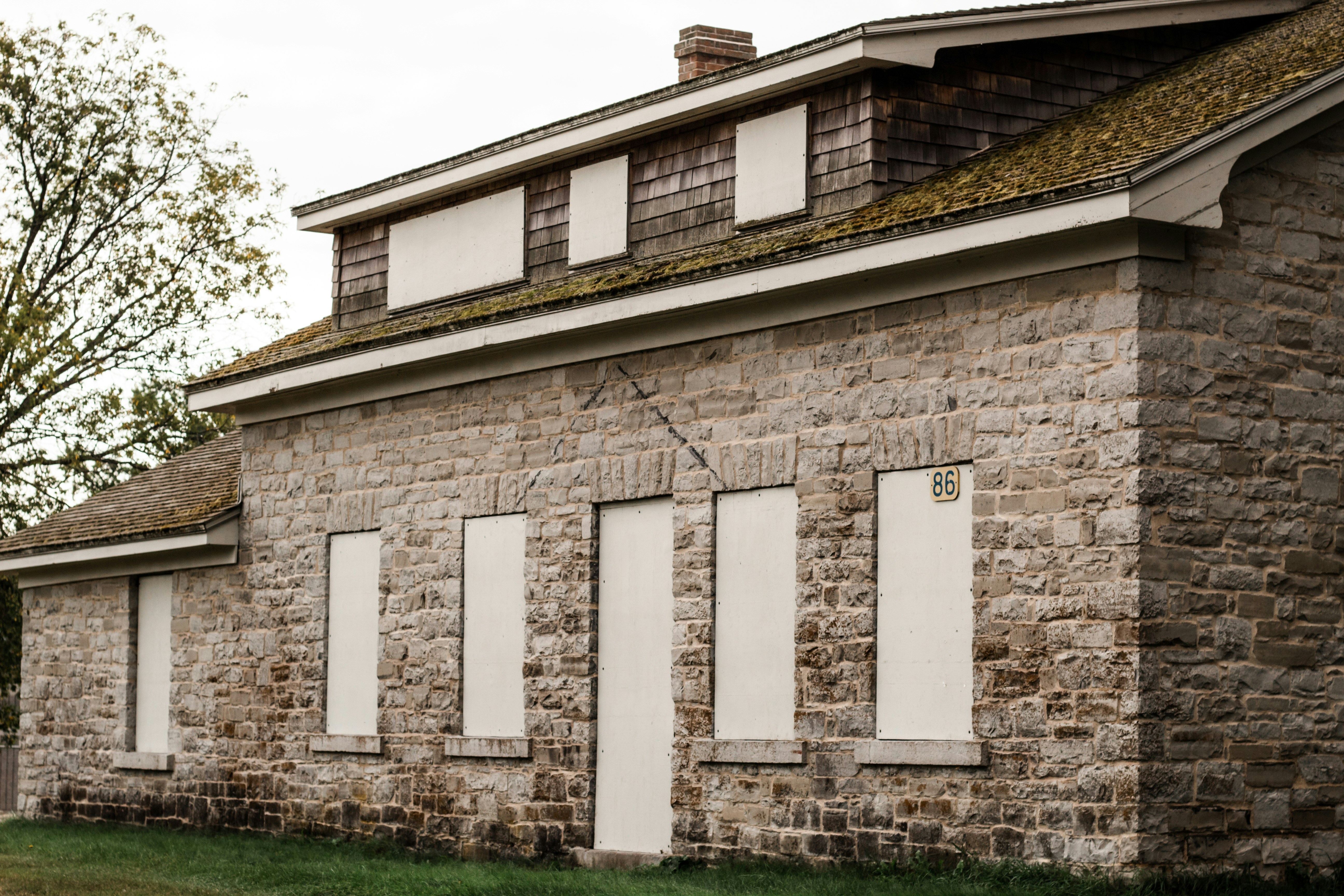 Abandoned Stone Warehouse with Weathered Shutters