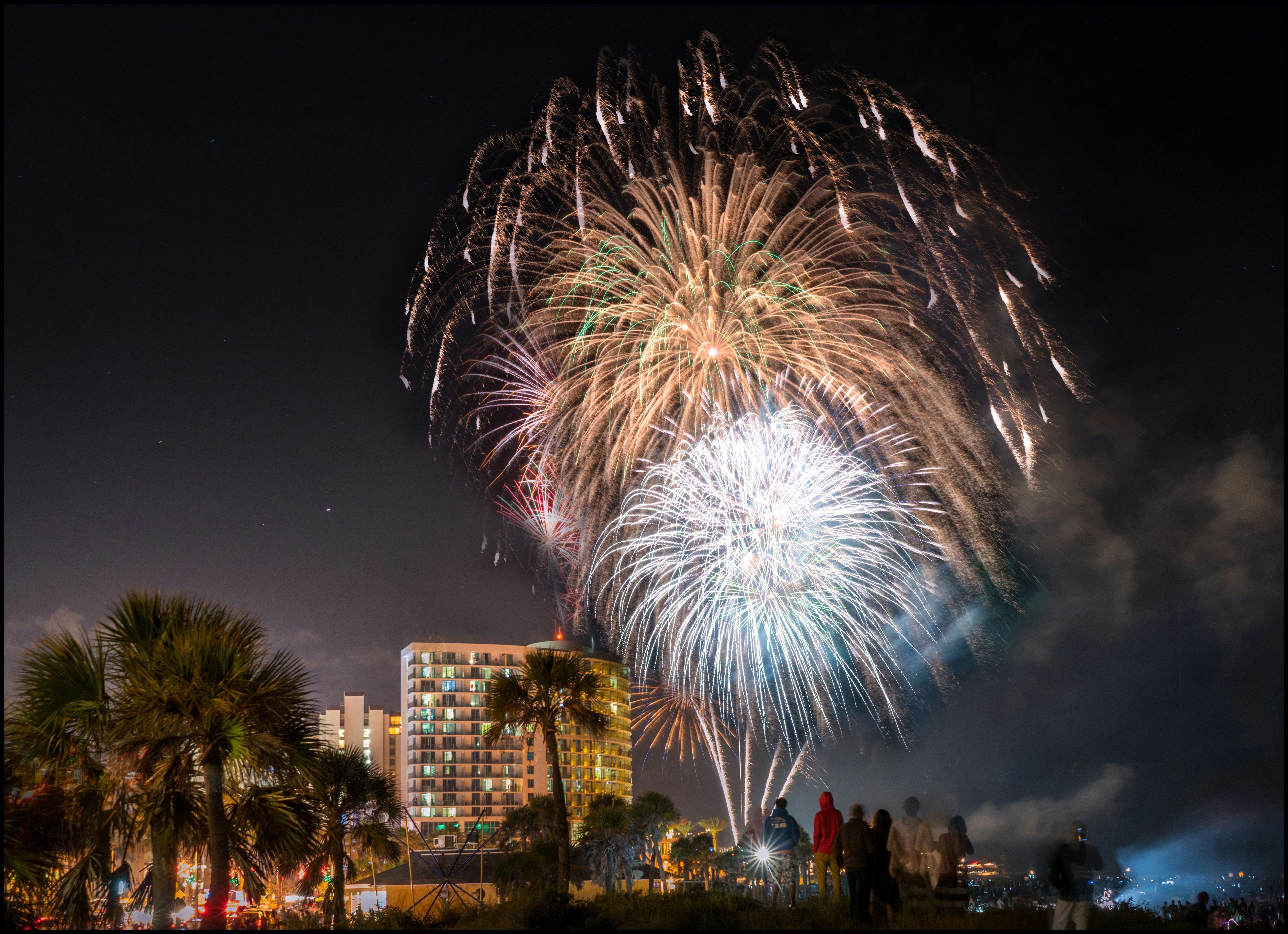 Fireworks display over city buildings during night time photo – Free ...