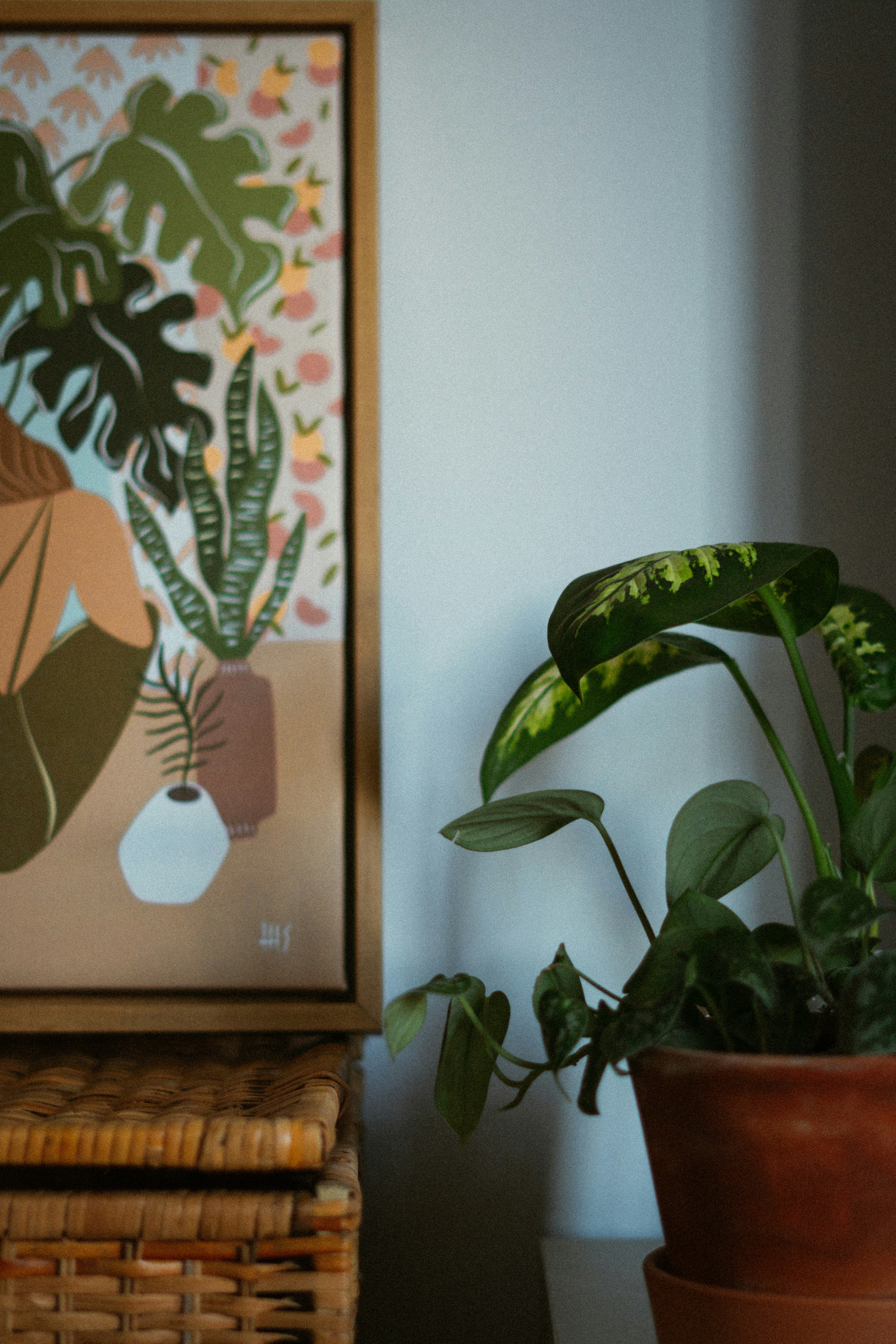 Illustration featuring a woman surrounded by lush plants, framed in a decorative border. The scene captures a serene indoor ambiance.