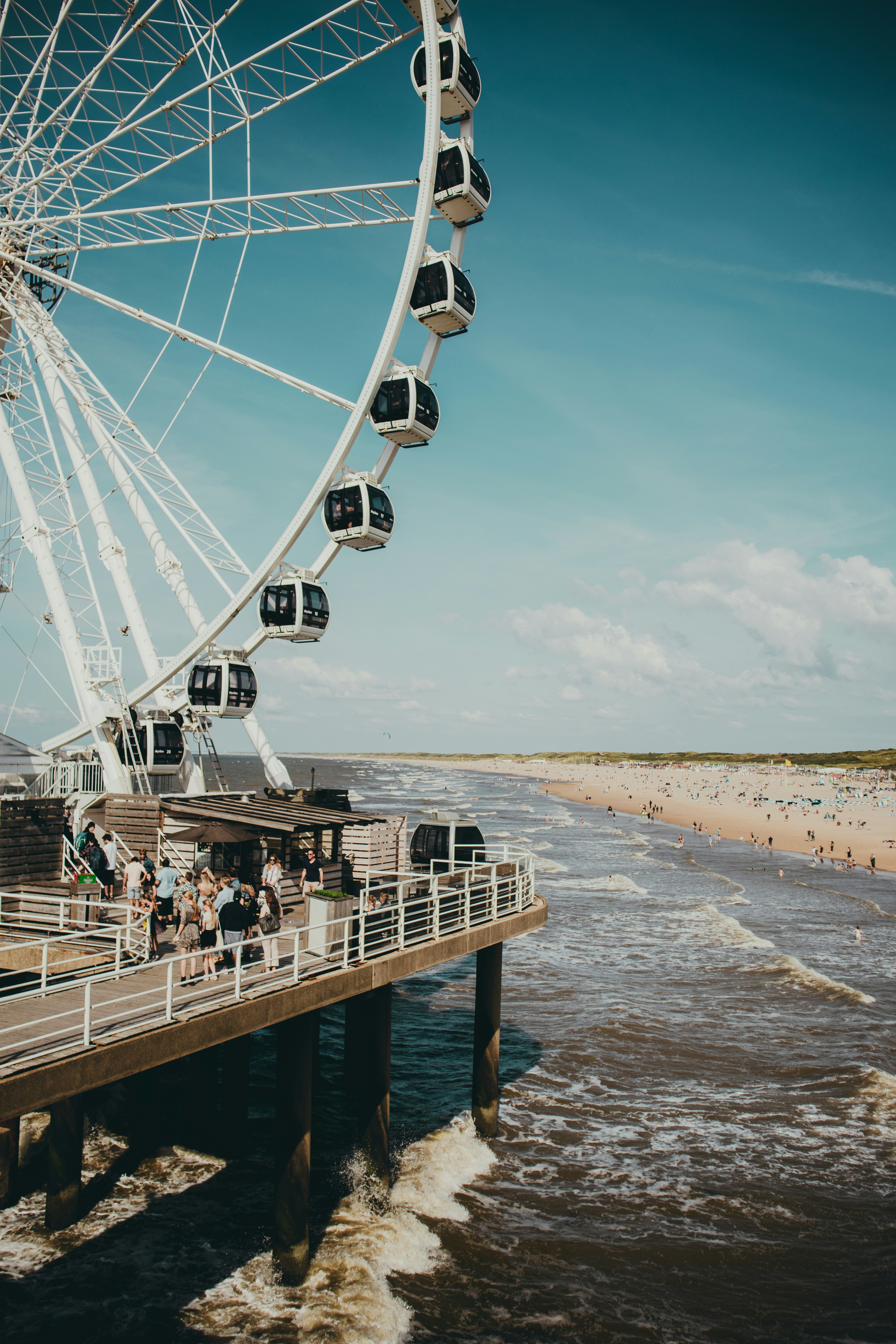 Giant Wheel at the Pier: Sunlit Beach Panorama