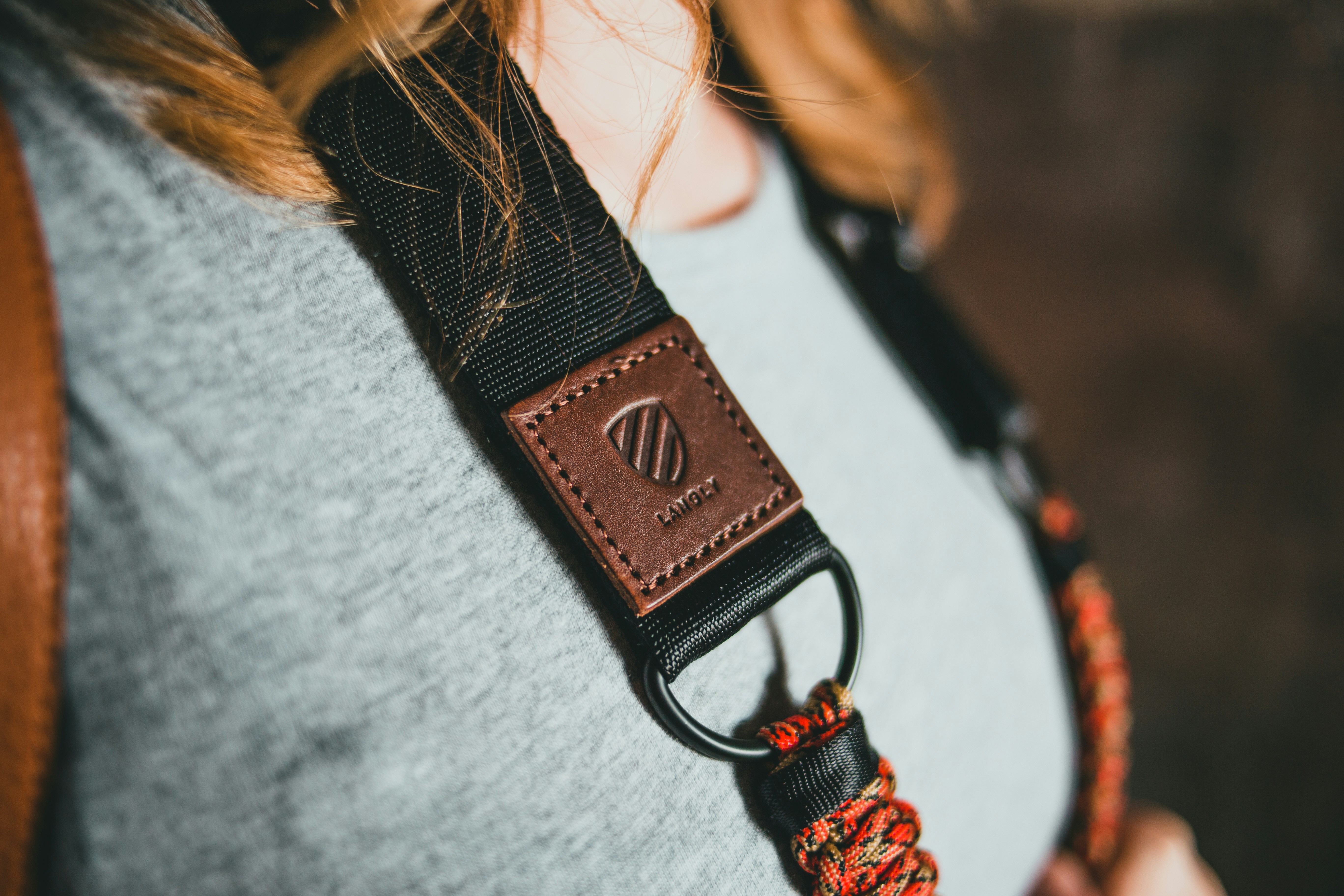 Strapped in Focus: Leather Accent and Cord on a Soft Gray Tee