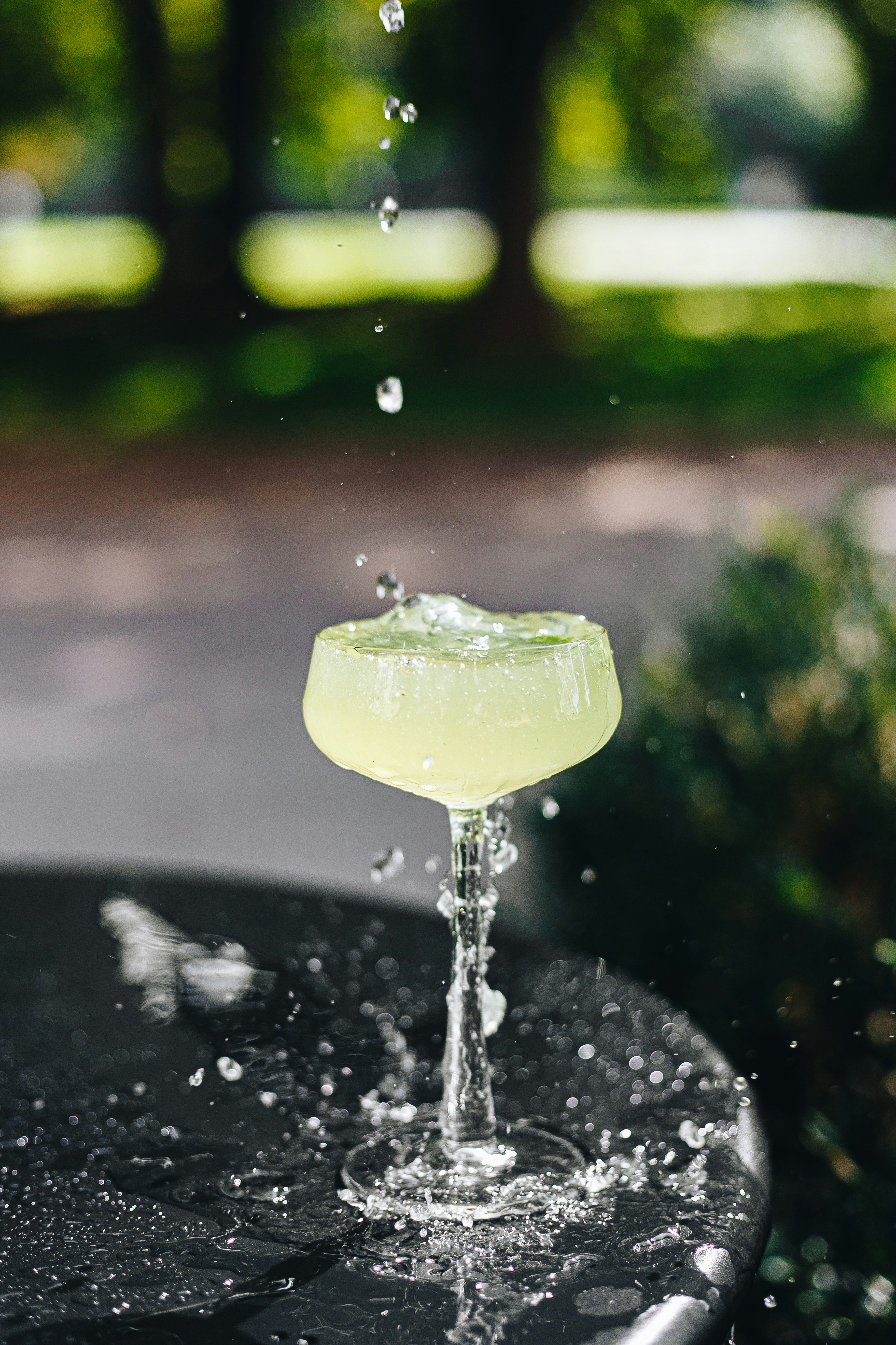 Lime-Frosted Coup: Droplets Leap from a Margarita on a Rain-Sparked Table