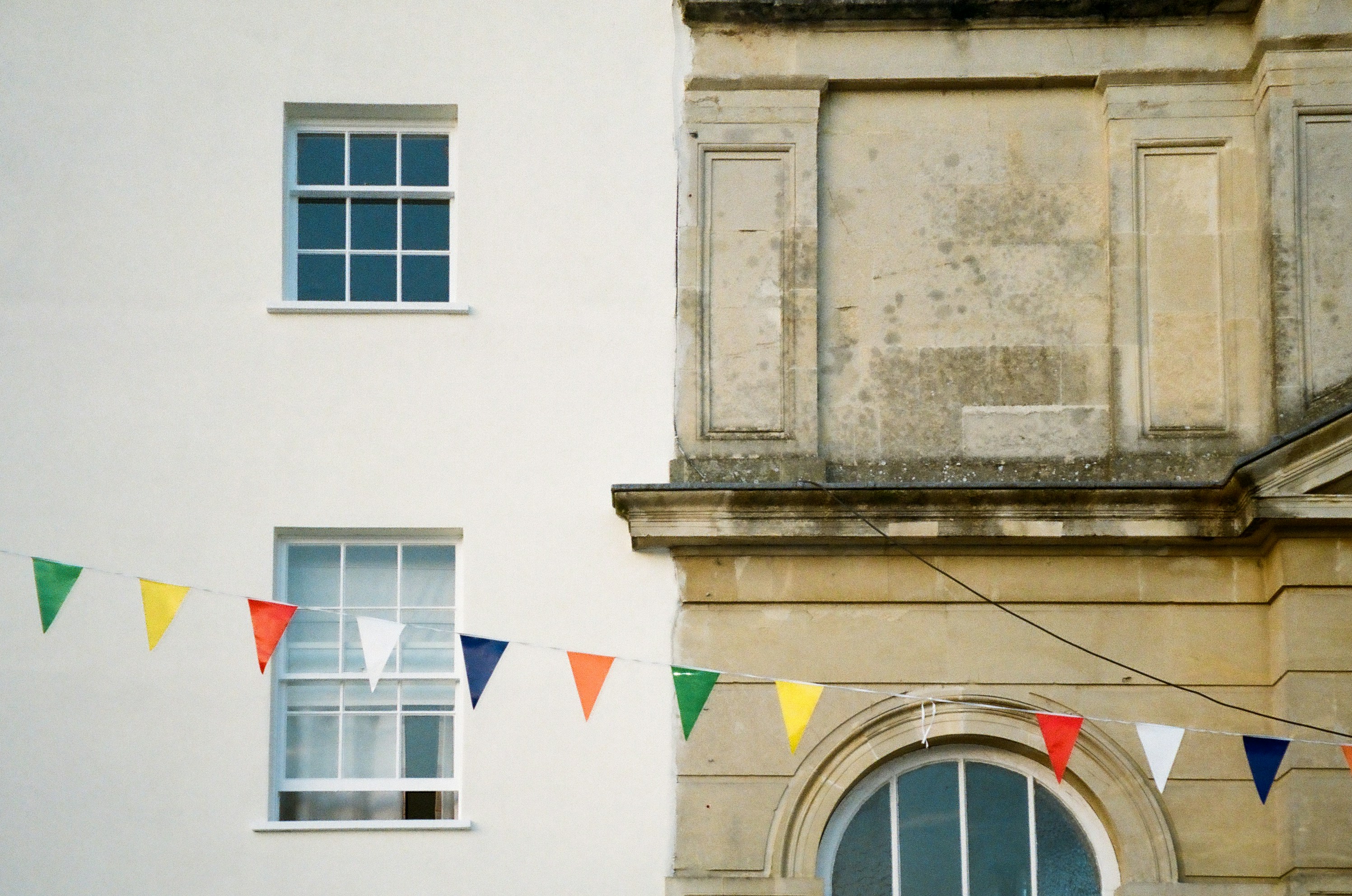 A building with a bunch of flags hanging from it's side photo – Free ...