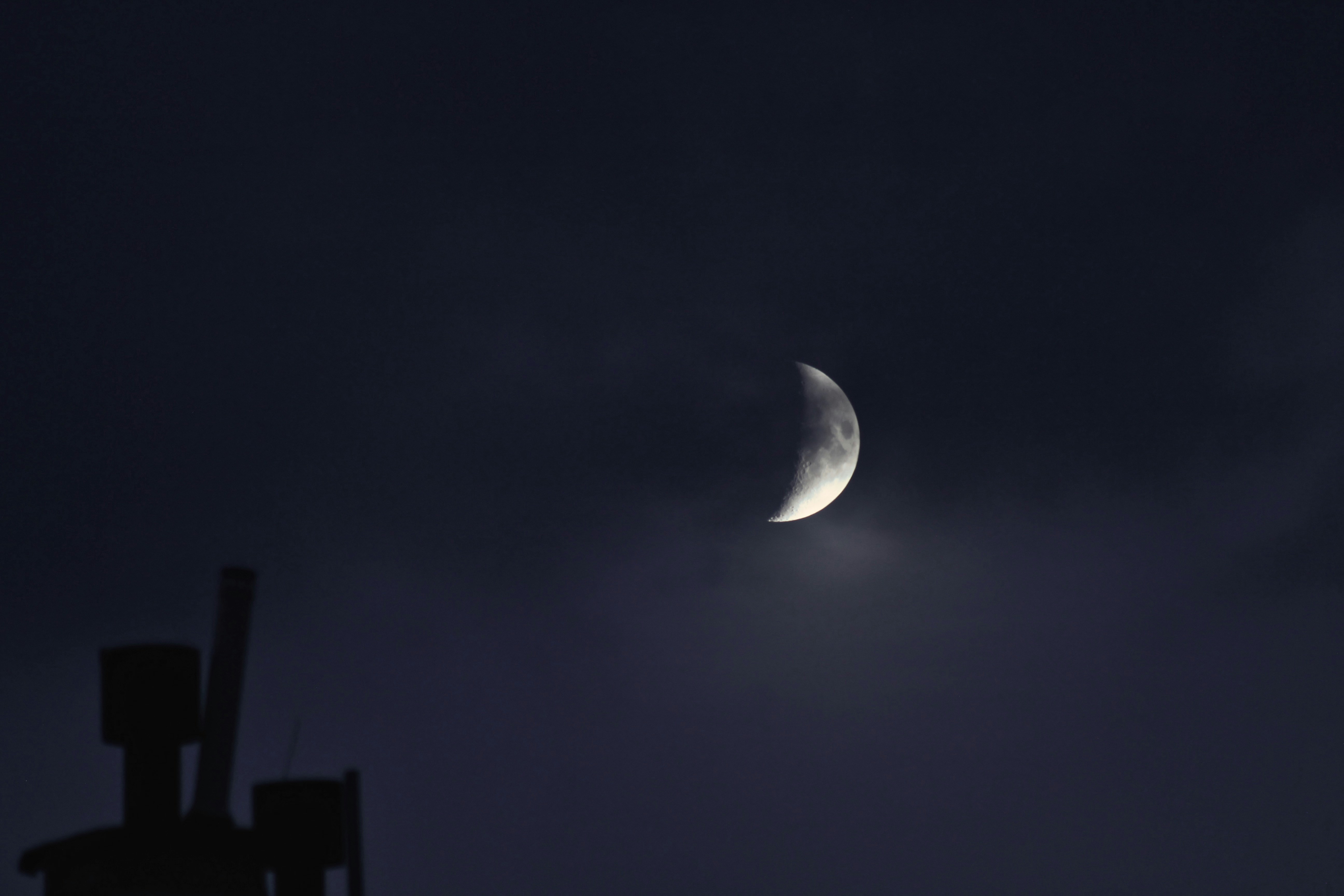Crescent Moon Between Night Veil Over Rooftop Silhouettes