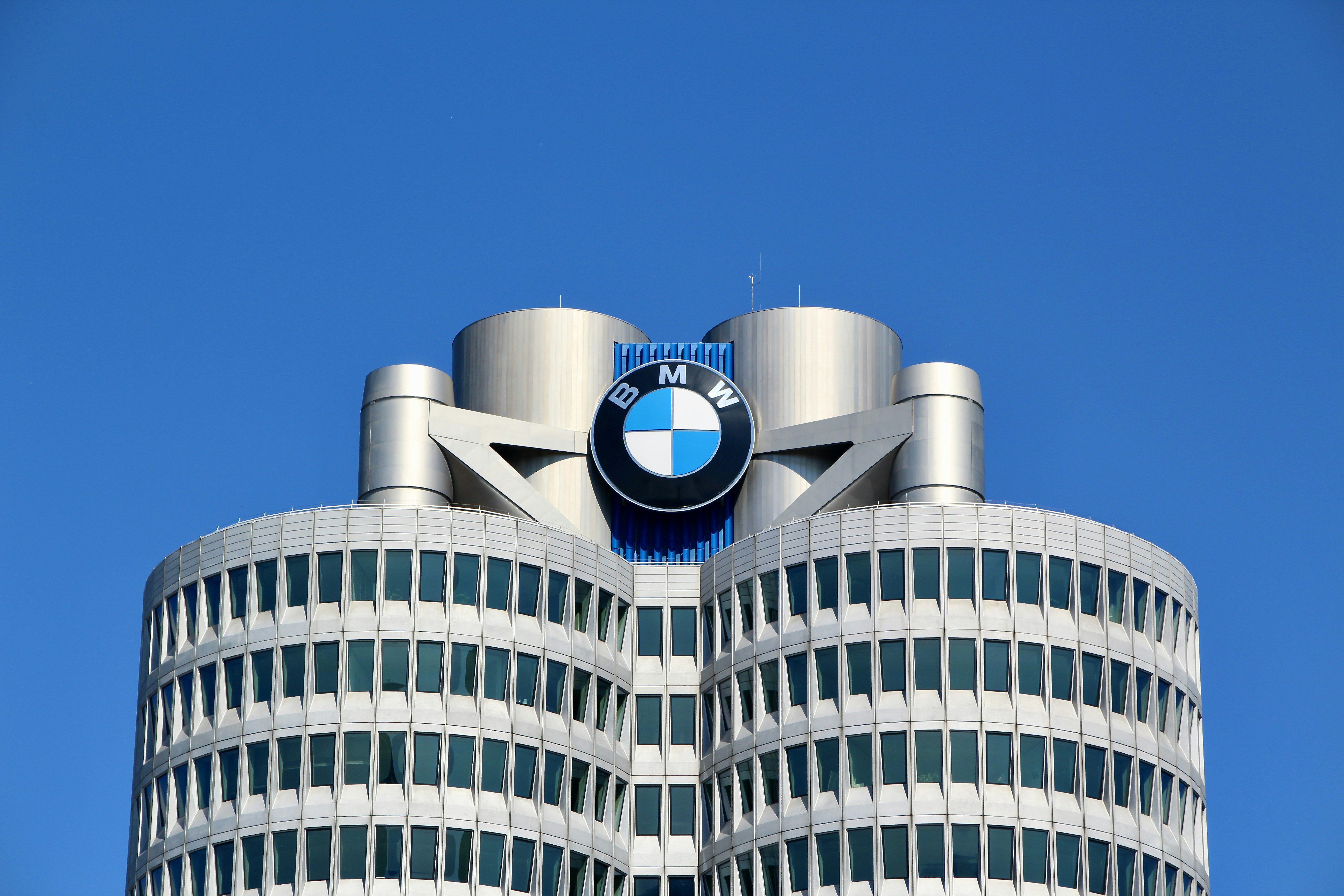 A tall building with a bmw logo on top of it photo – Free Germany Image ...