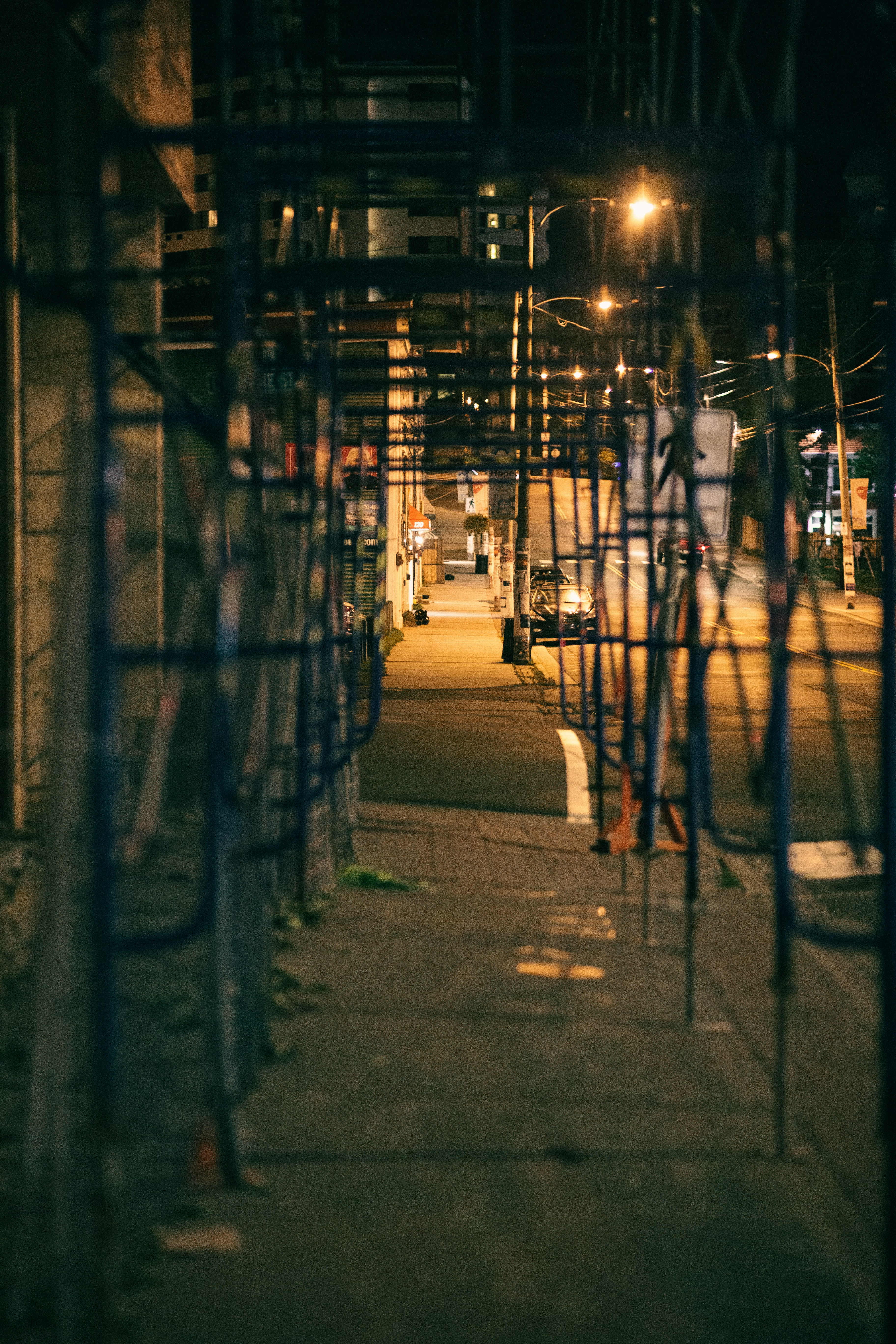 Night Passage Through a Scaffolded Alley