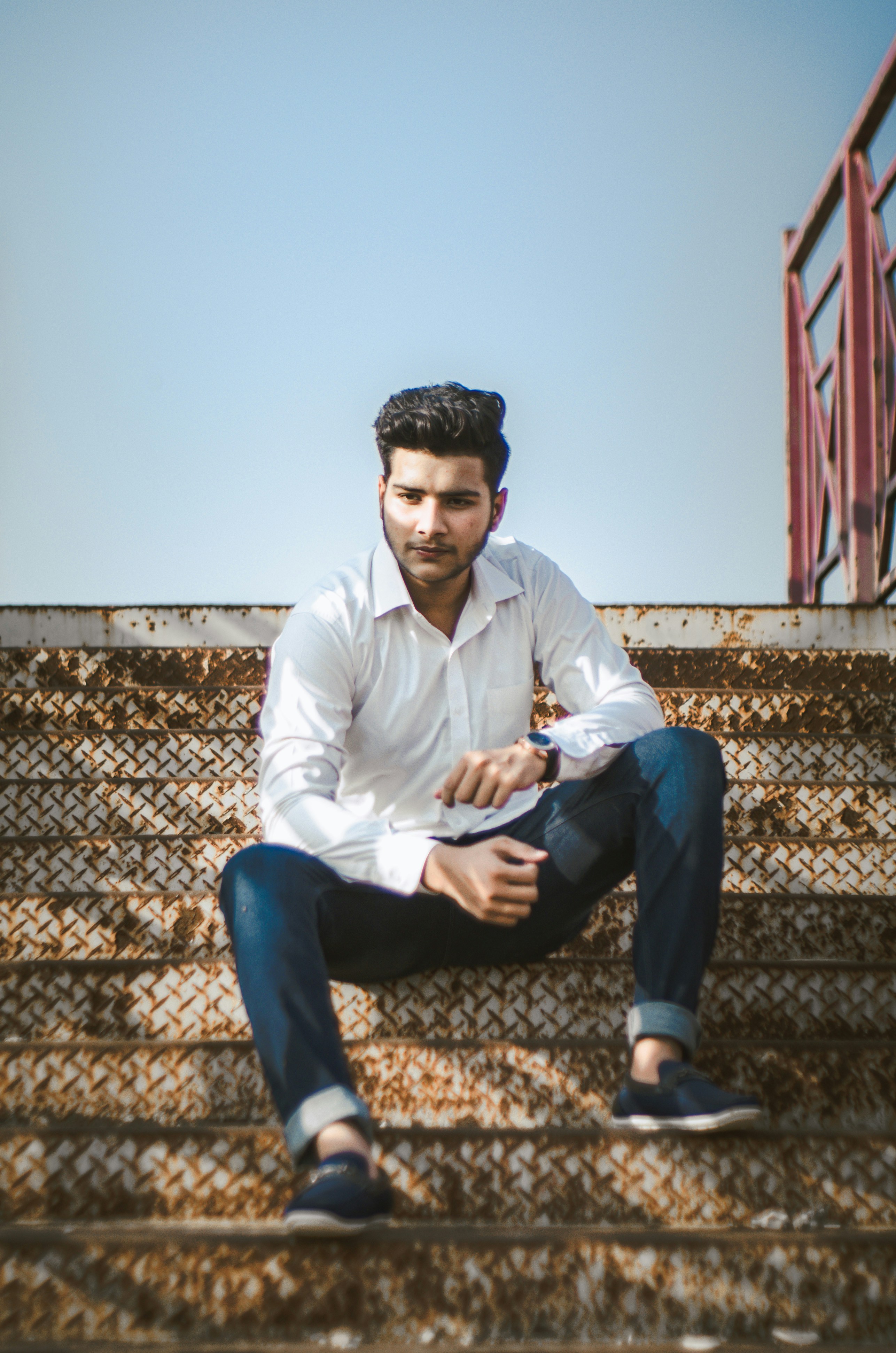 A man sitting on a set of stairs photo – Free Man Image on Unsplash