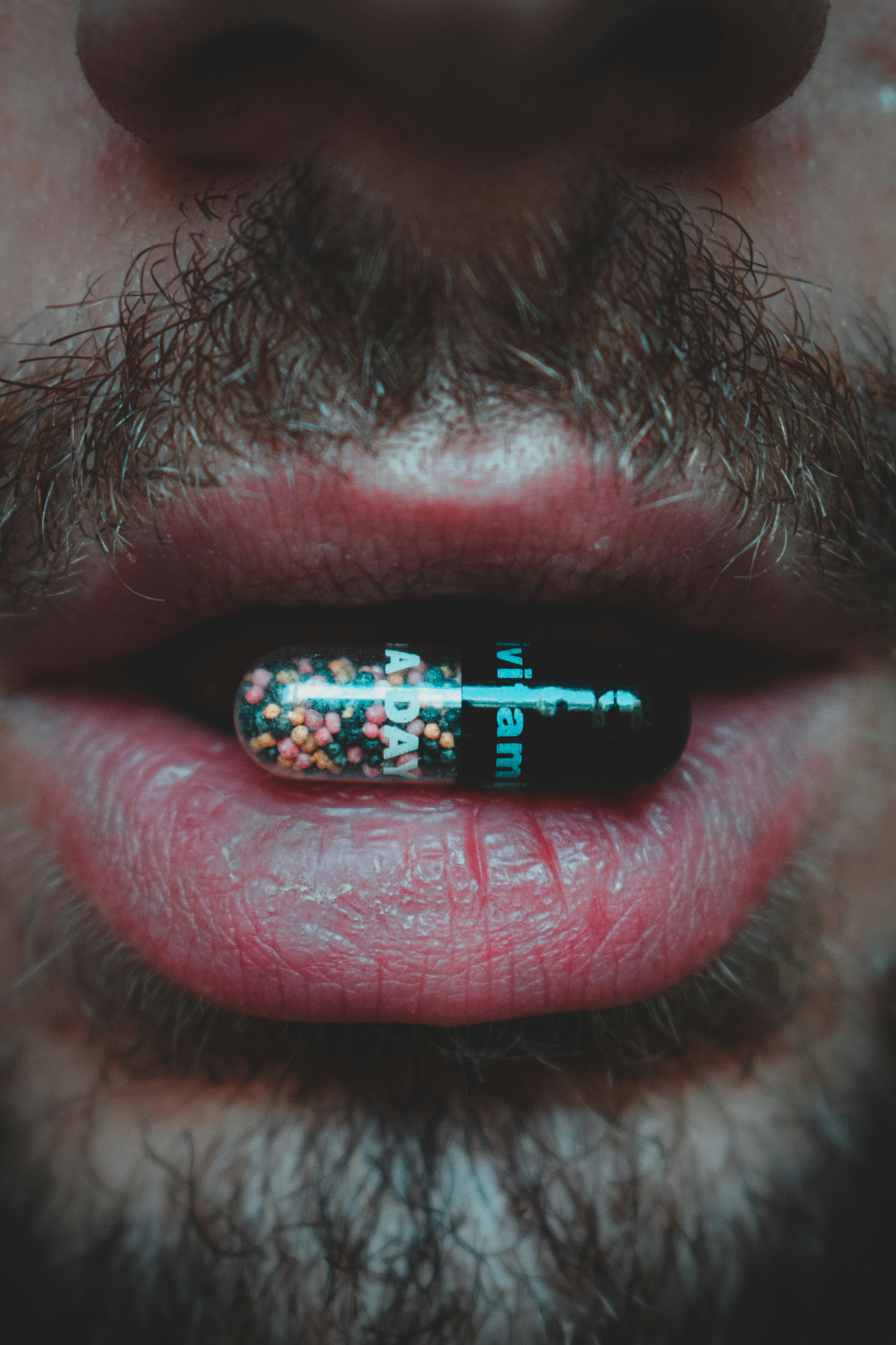 a close up of a man's lip with a pen in it