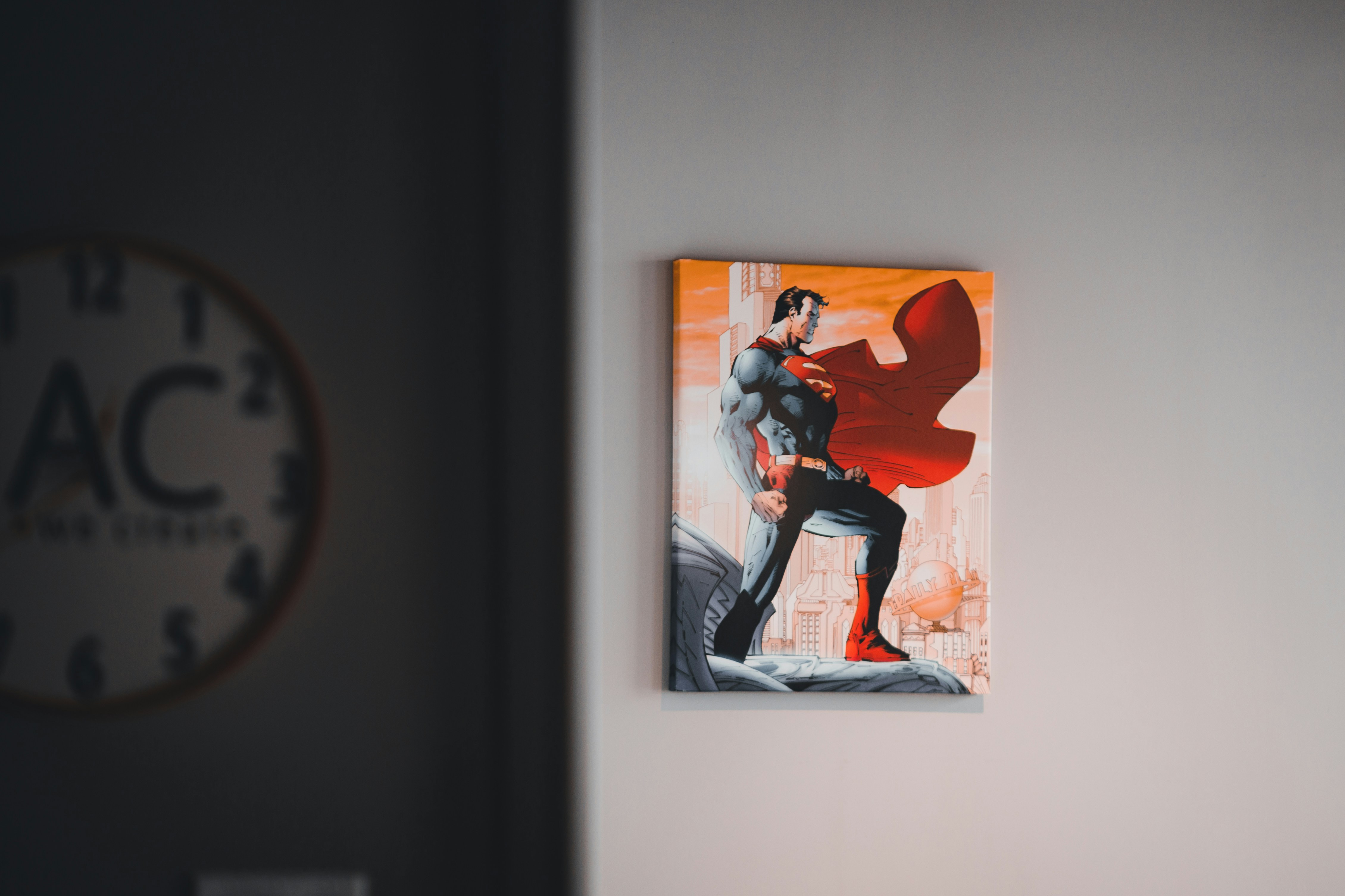 Hero on the wall: a framed superhero portrait in warm light