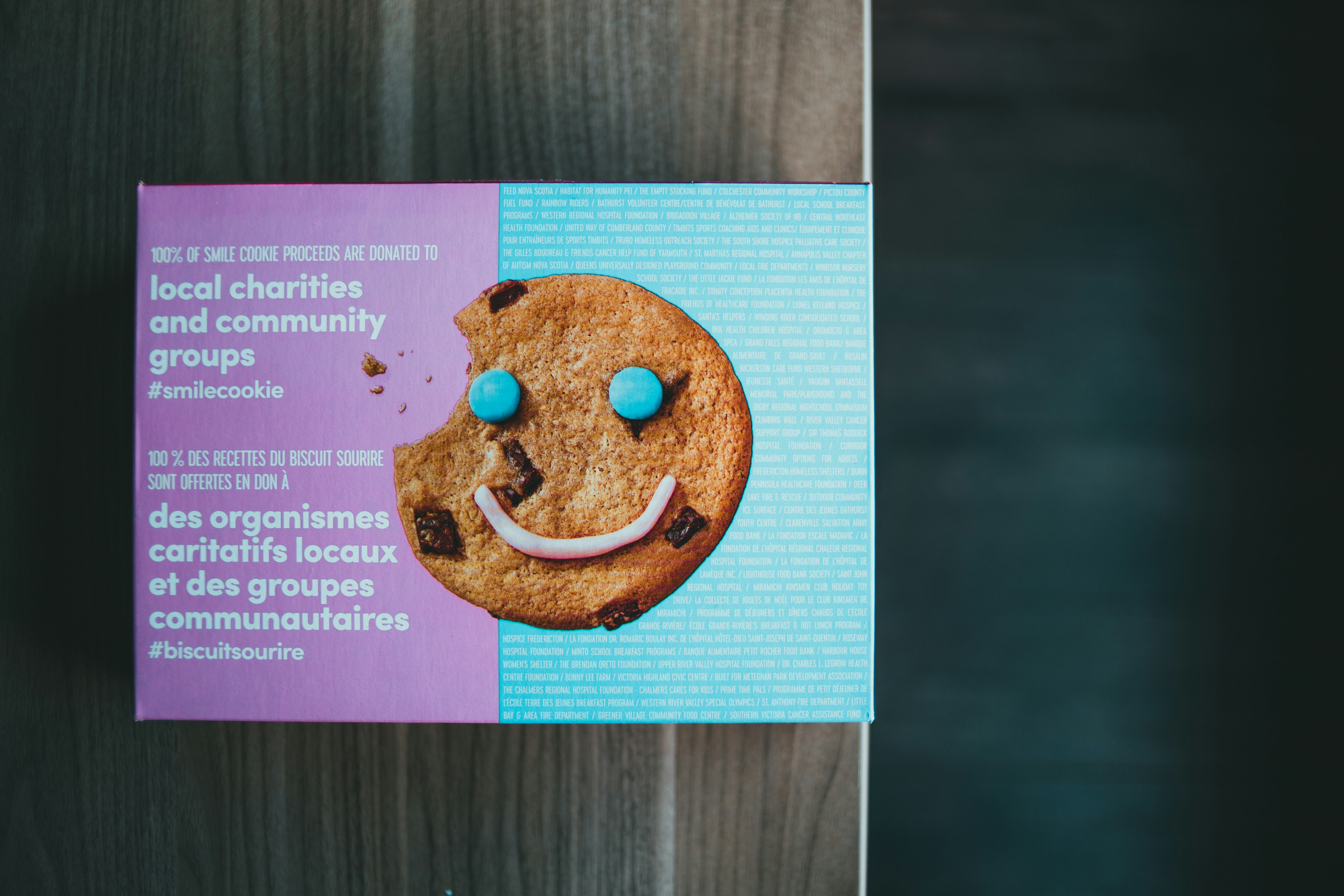 Smiling cookie carton on a split-colored panel