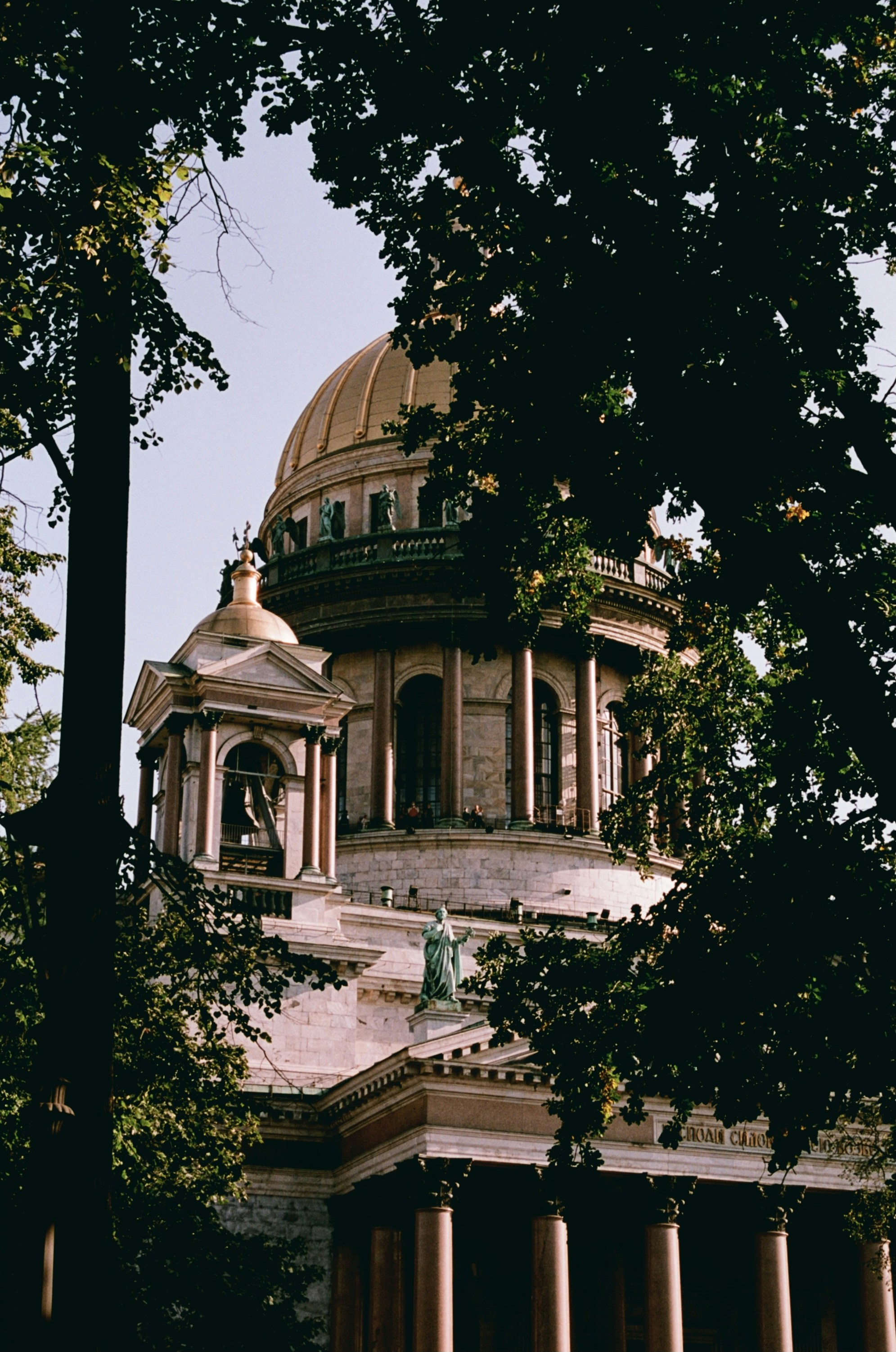 The dome of a building with columns and a statue photo – Free ...