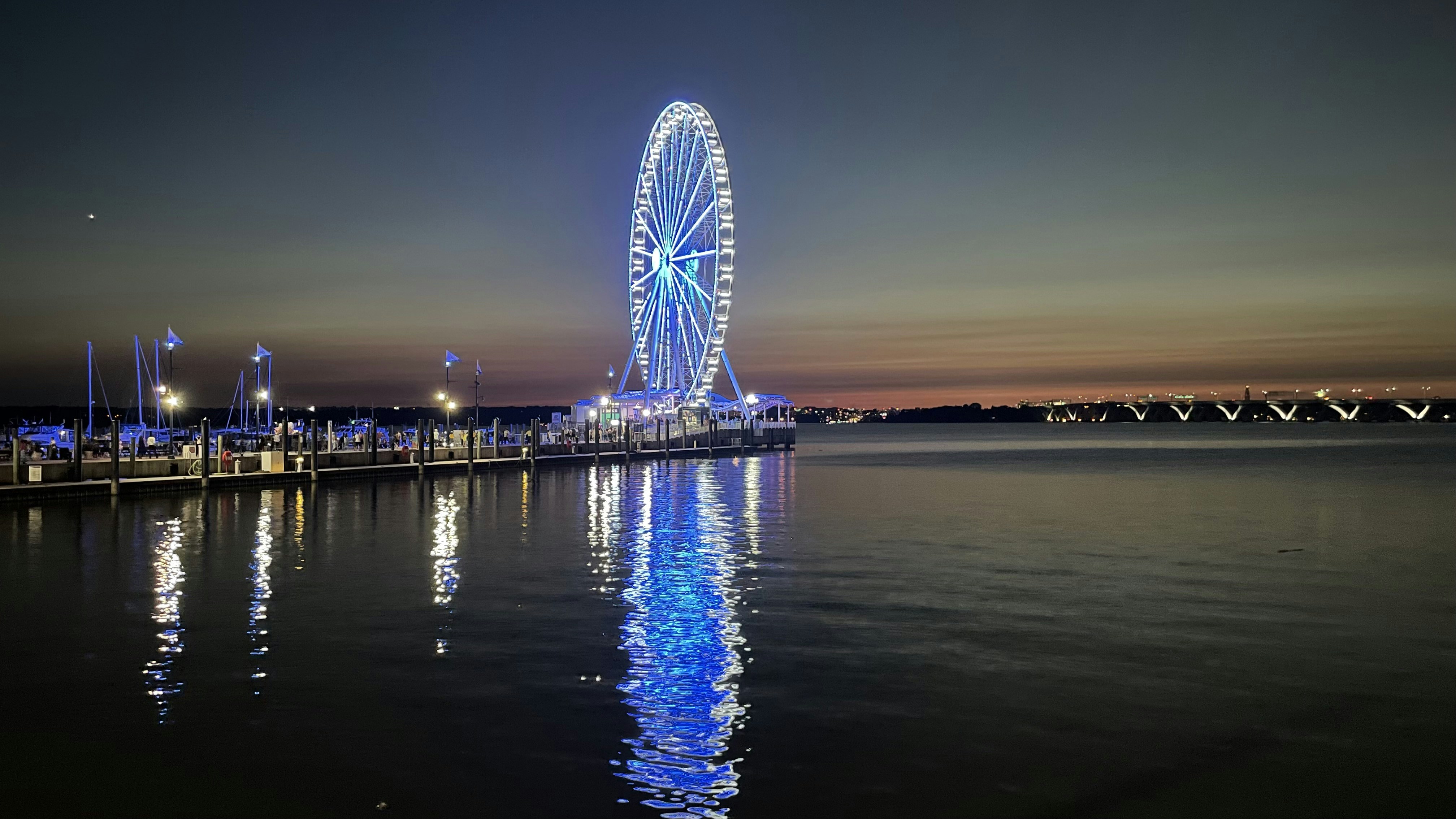 National Harbor  | a ferris wheel is lit up at night