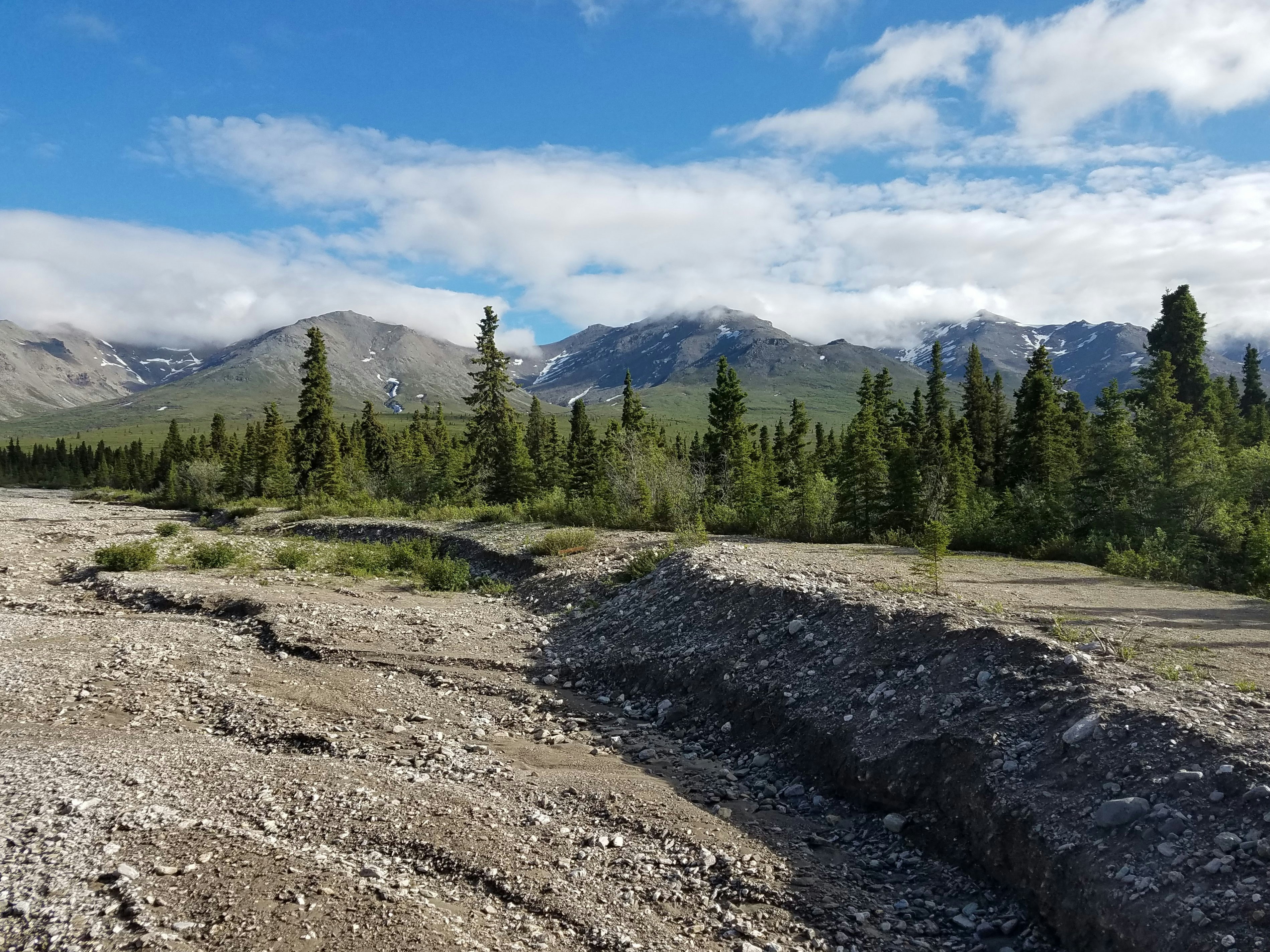 Ridge of Stones: A Quiet Traverse Toward Snowy Peaks