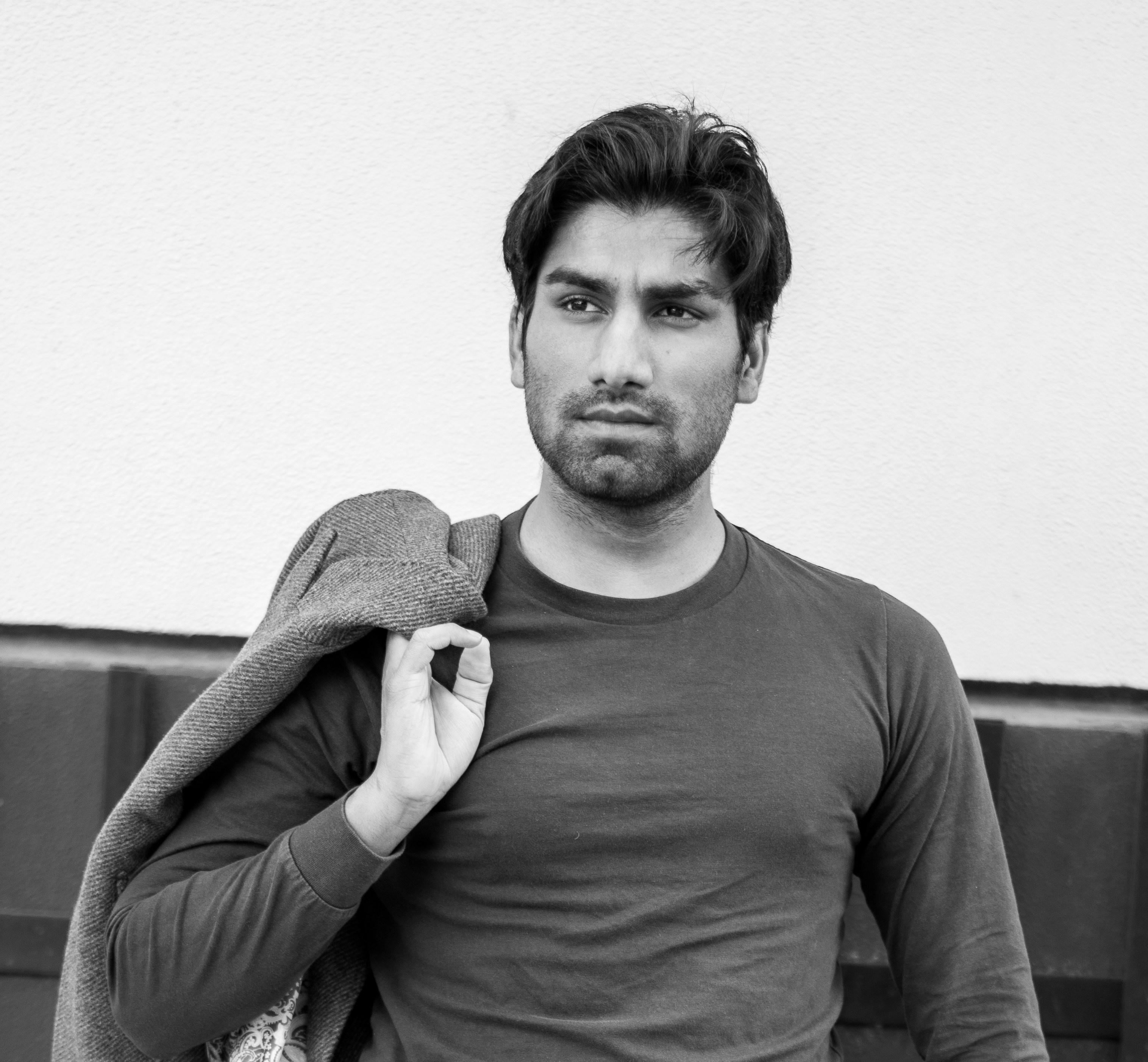 A man is holding a coat over his shoulder photo – Free Male pose Image ...