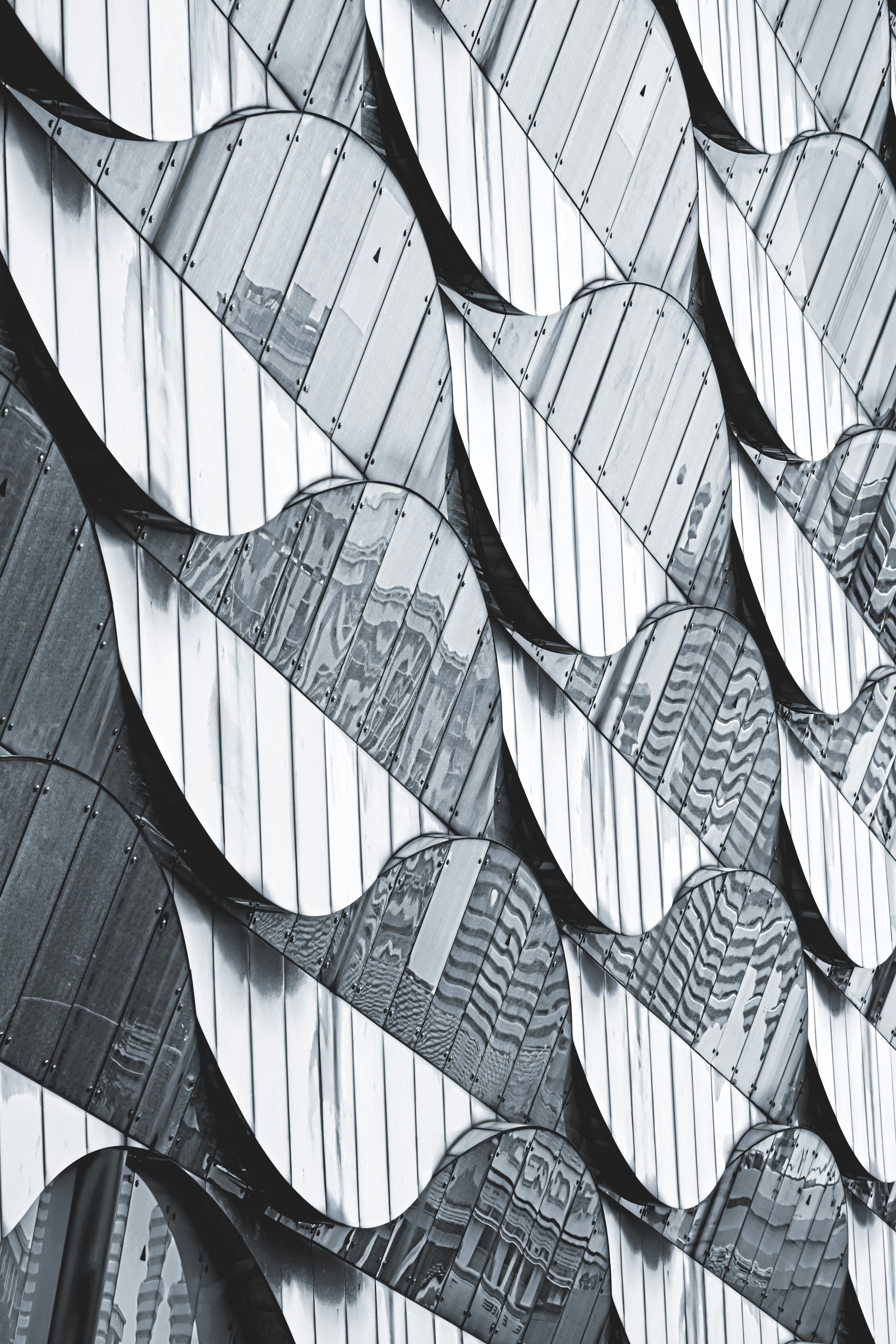 a black and white photo of a wall of mirrors