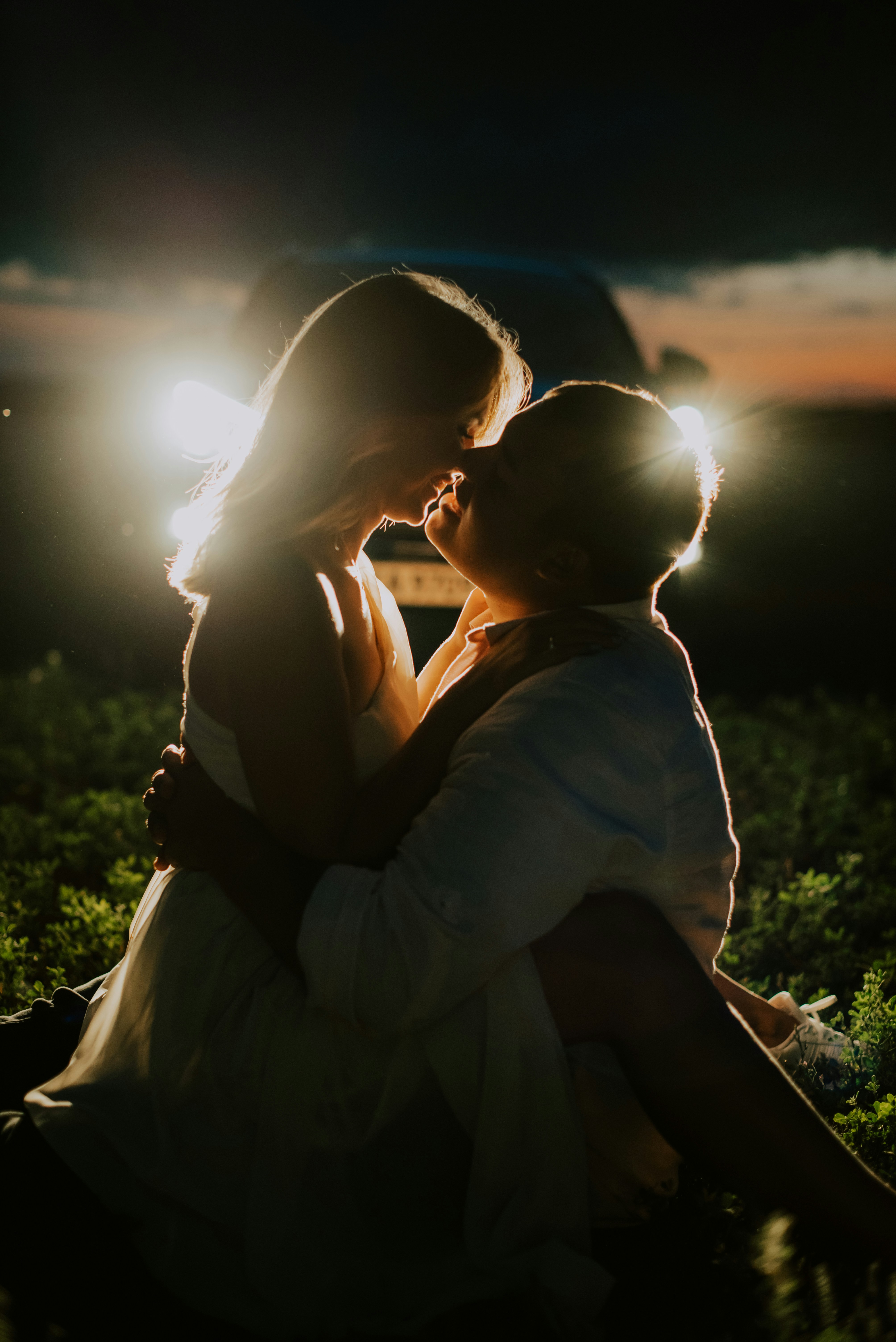 Silhouetted Vows: Two Lovers Foregrounded by a Solar Kiss
