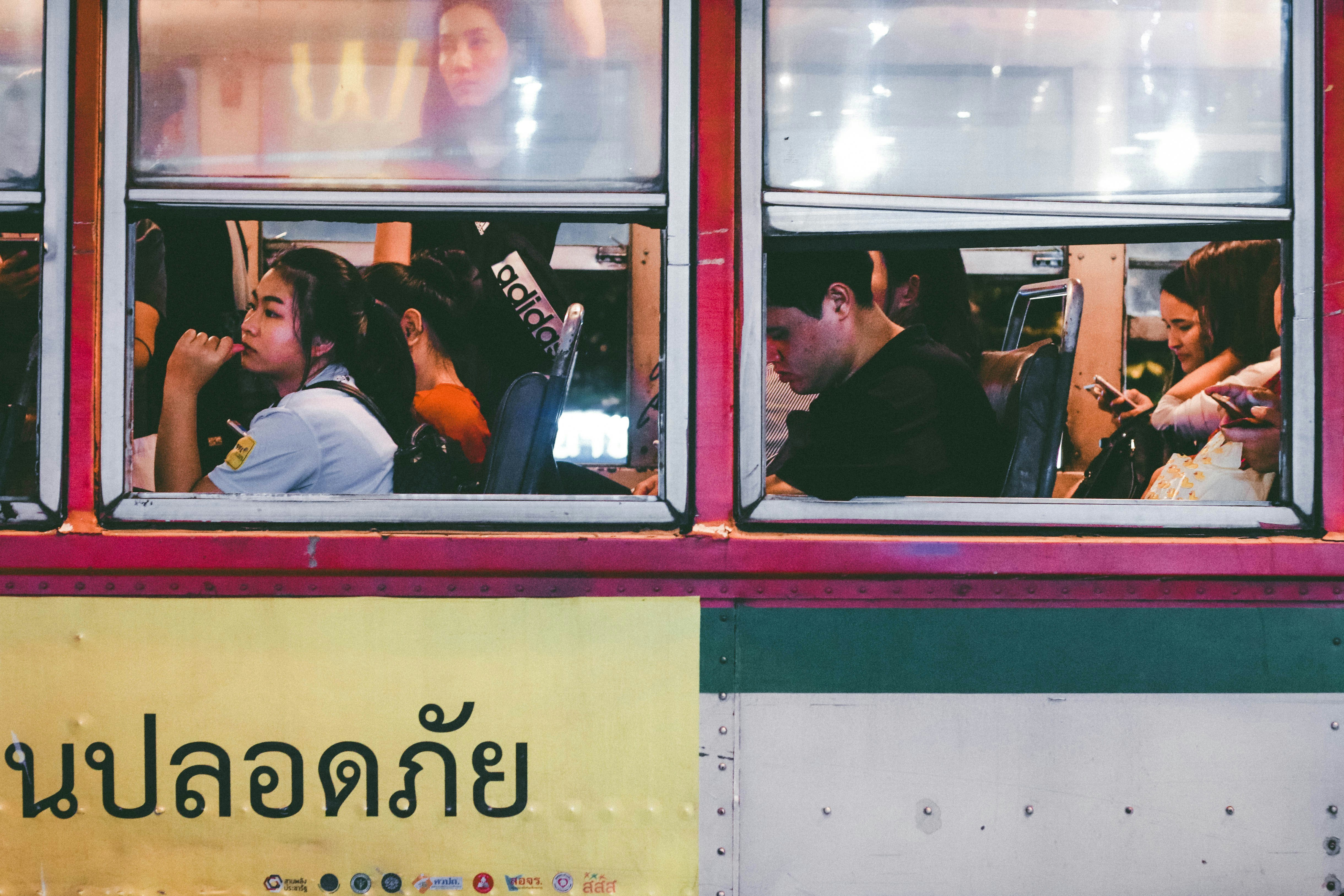 A group of people sitting inside of a bus photo – Free Bangkok Image on ...