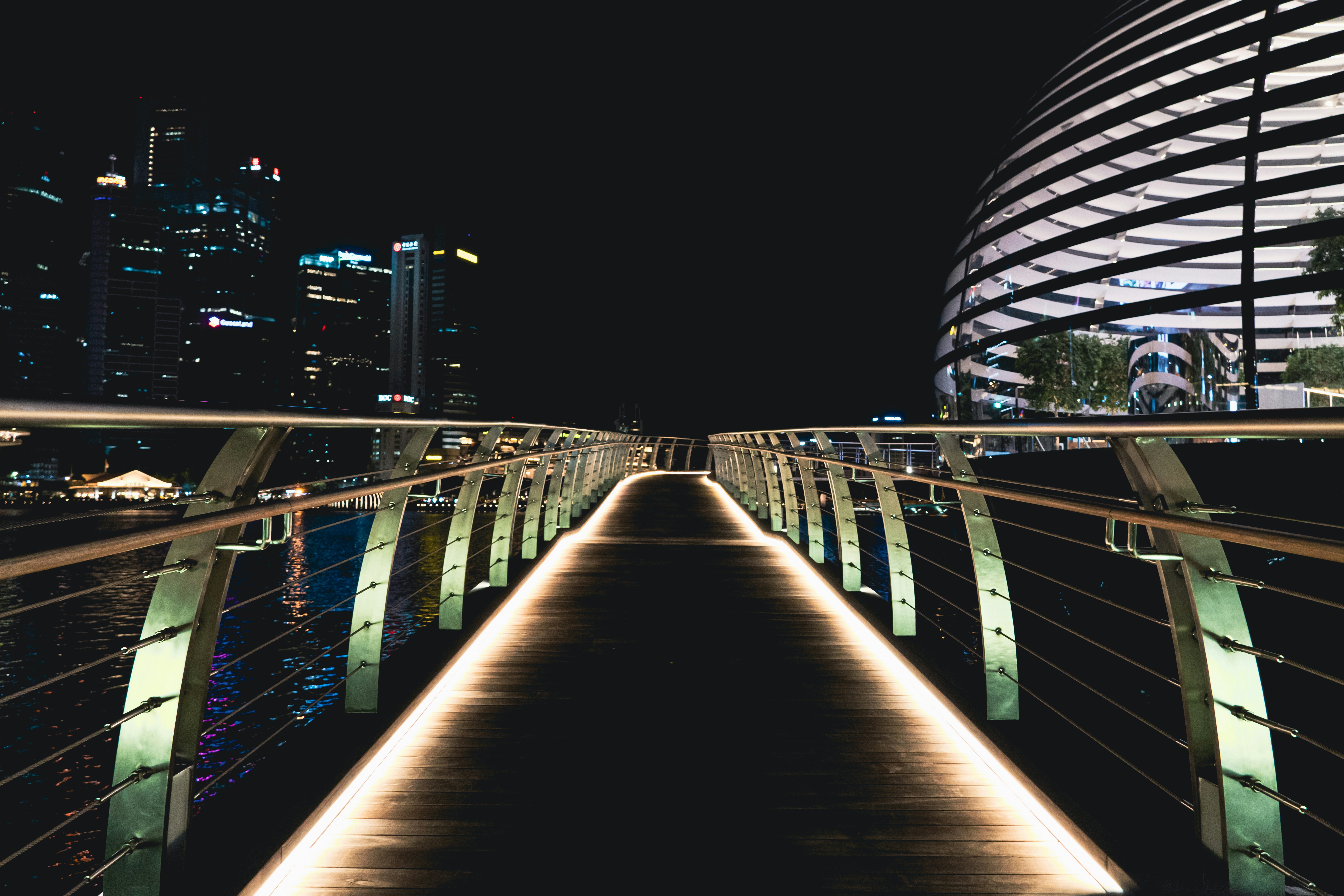 Midnight Neon Arches: A Quiet Walk Toward the City Skyline