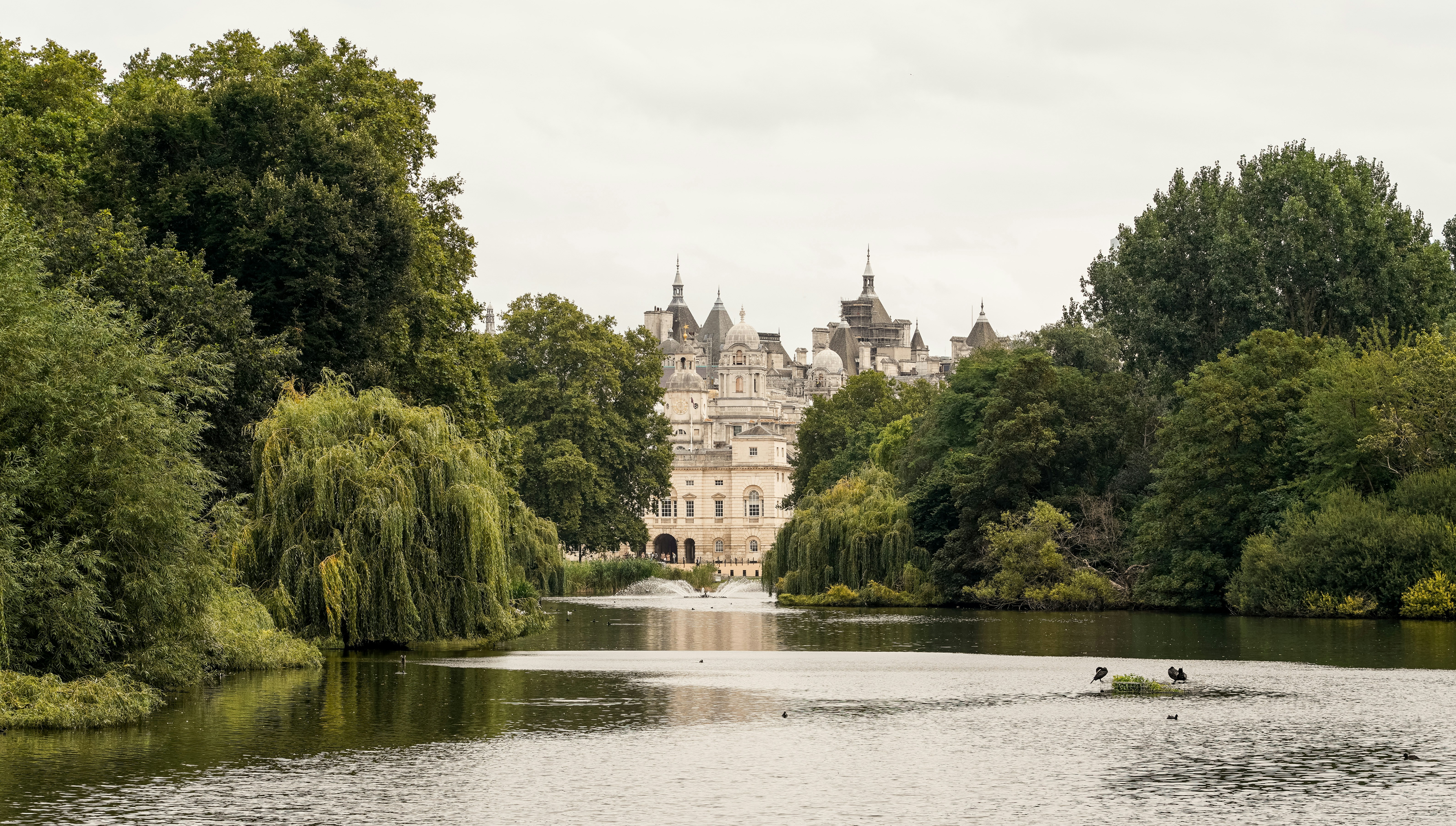 Castle Gate at Distant Lake: Verdant Arches Framing a Timeless Facade