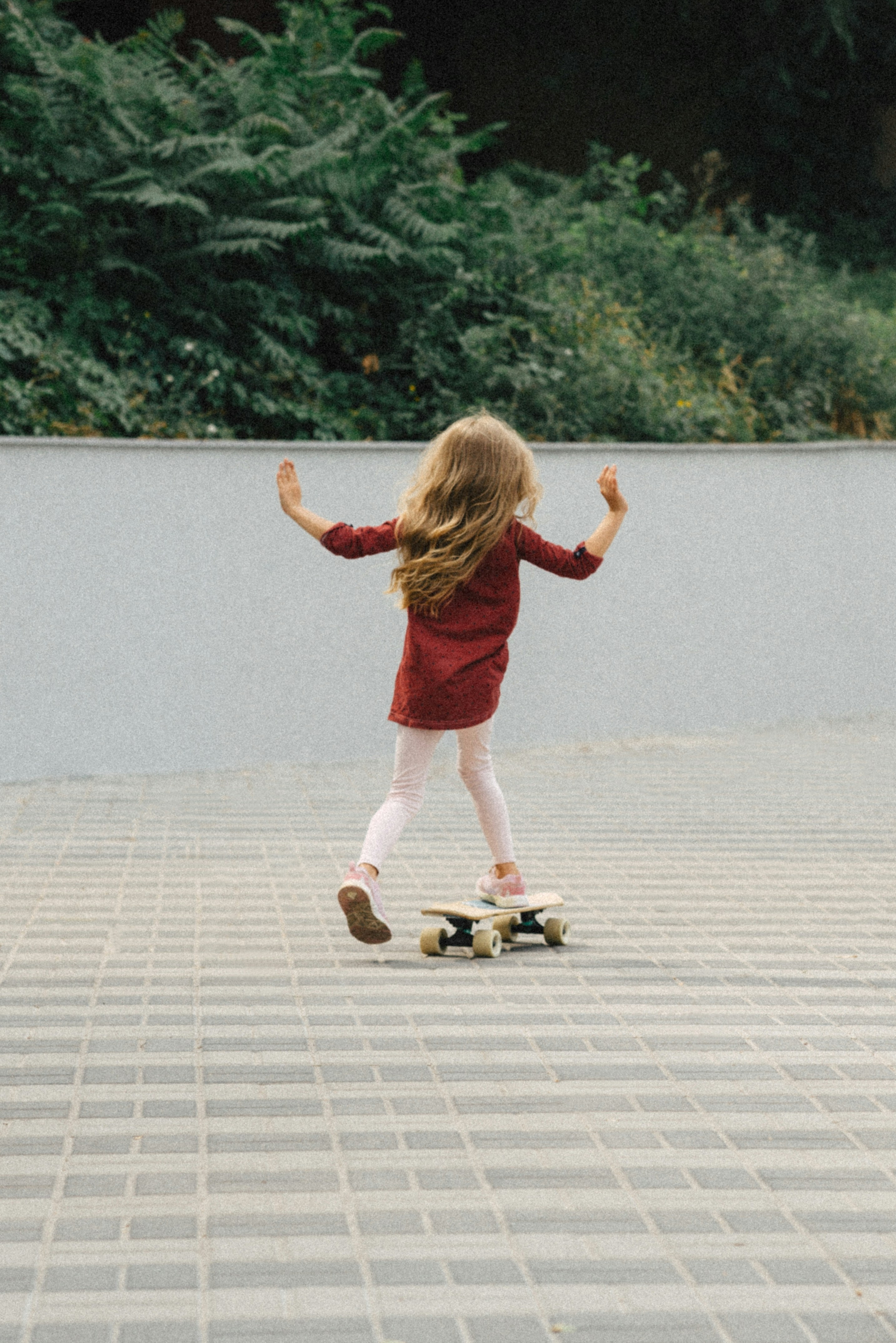 Red-Dress Rider: A Quiet Glide Across the Checkerboard Plaza